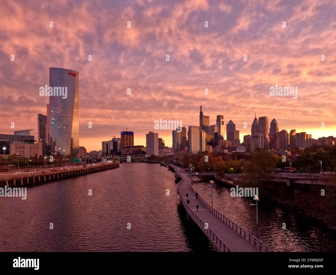 Sunrise lights up the clouds above the Philadelphia skyline, as seen ...