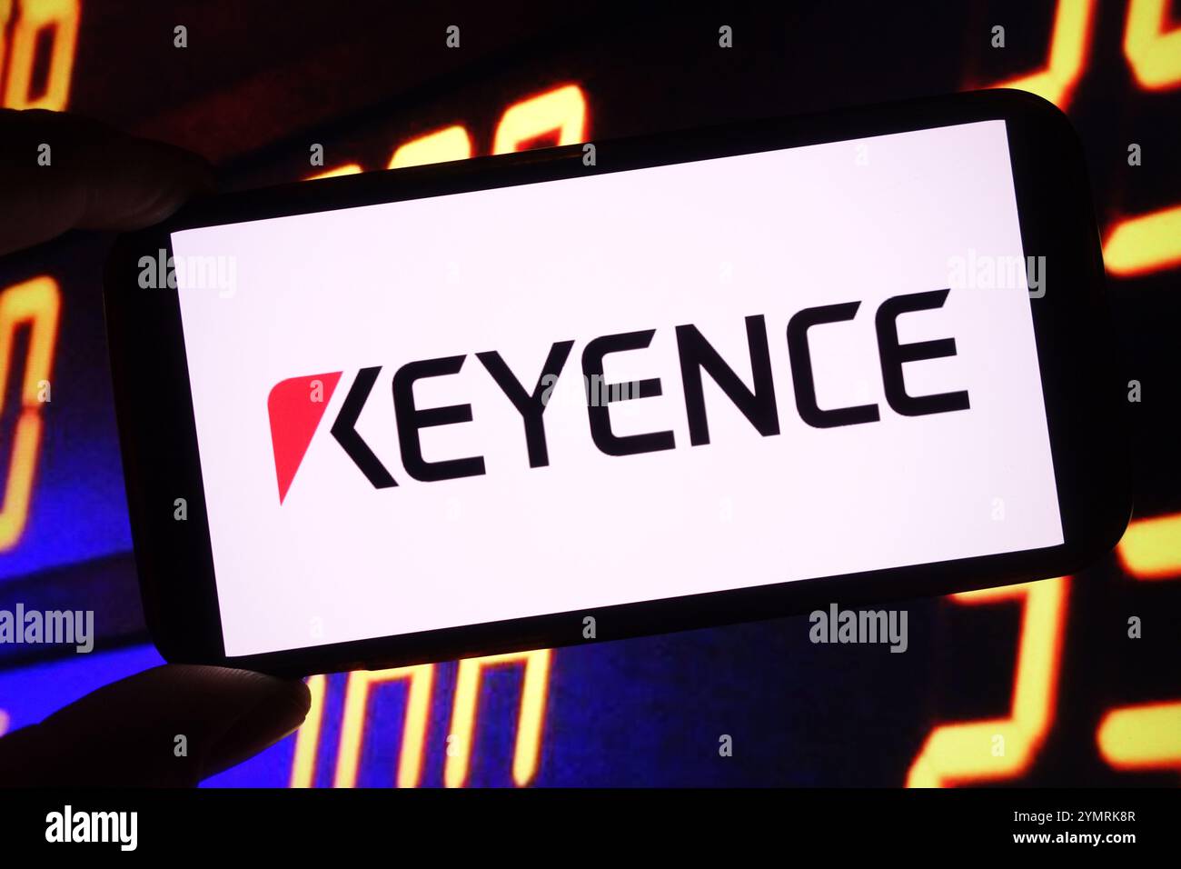 In this photo illustration, the Keyence company logo is seen displayed ...