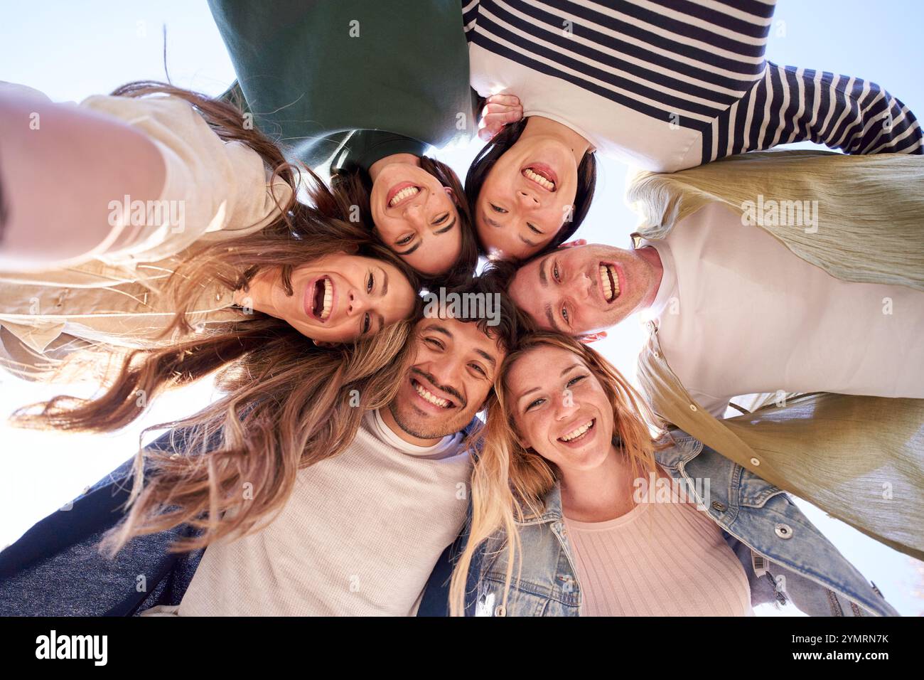 Selfie portrait from below of diverse gen z group friends posing ...