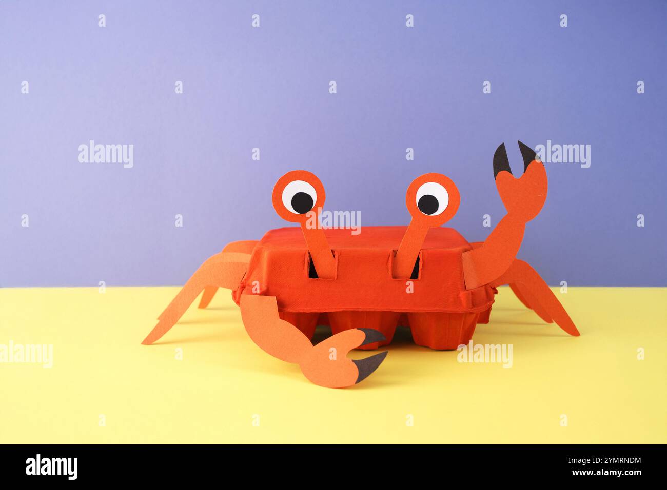 a craft project that resembles a crab. The crab is made from a orange ...