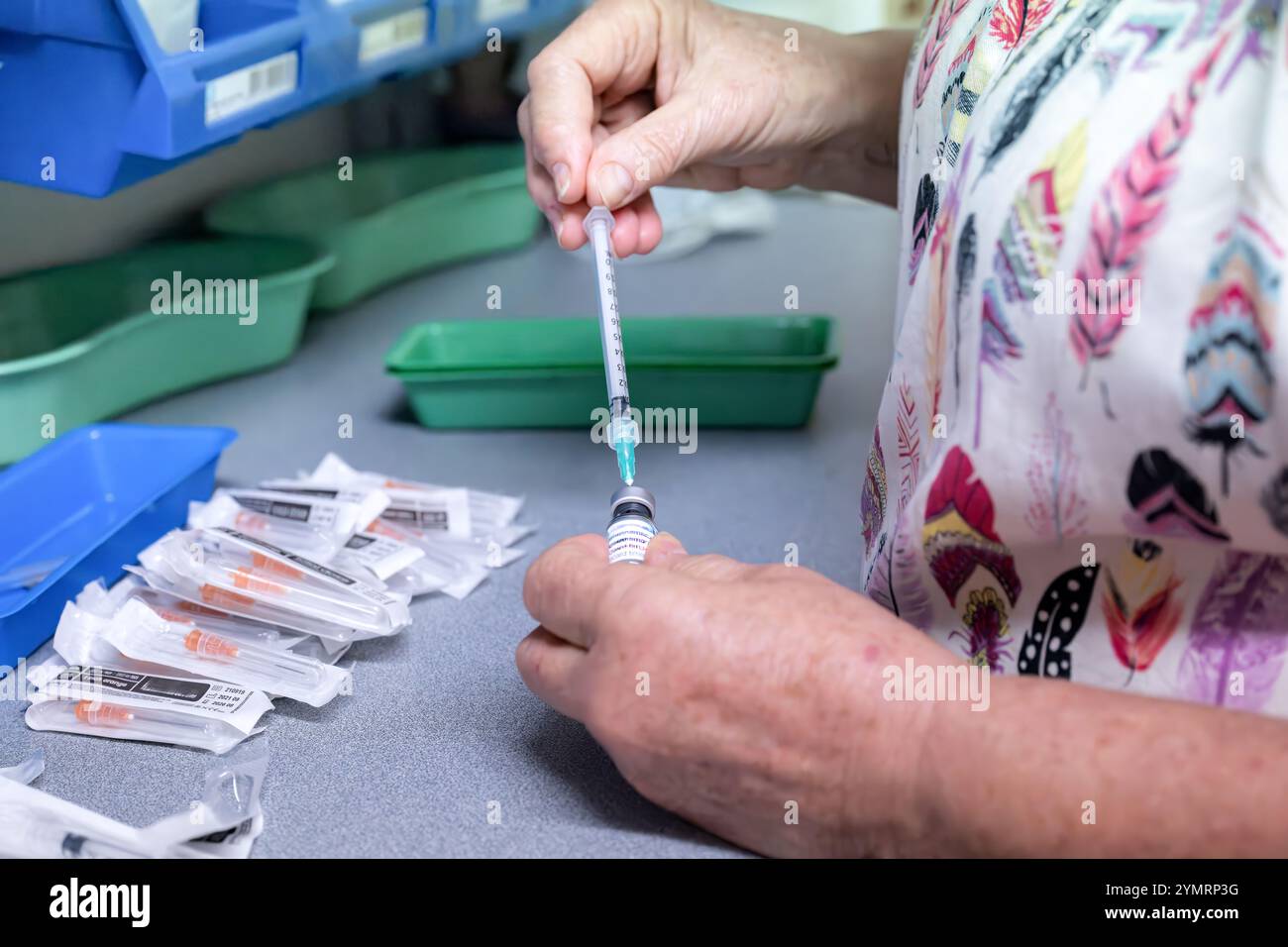 nurse drawing up vaccine in medical clinic, vaccination immunisation ...