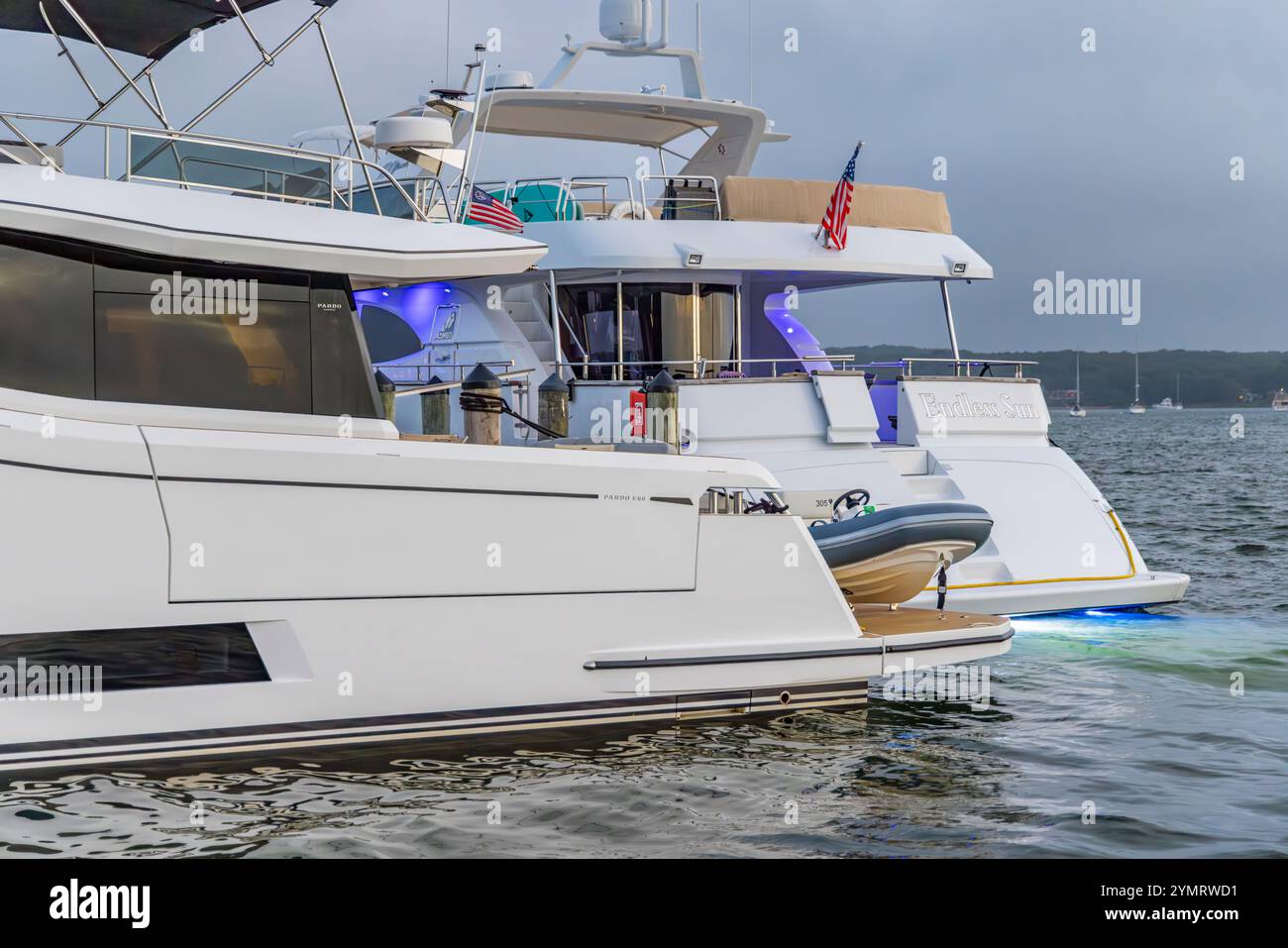 detail of the sterns of two motor yachts at dock in three mile harbor ...