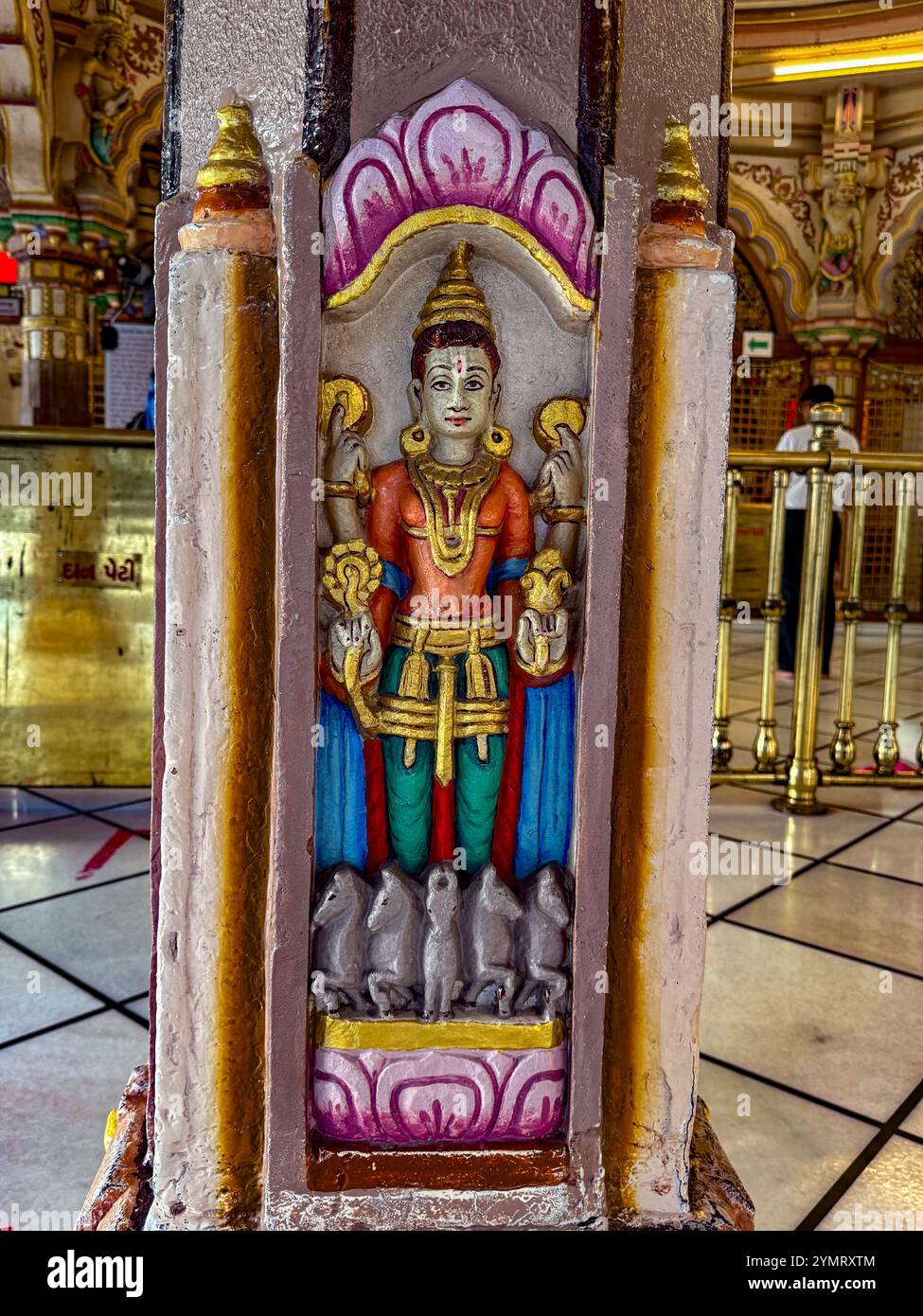 Vibrant bas relief of kubera, the hindu god of wealth, holding cymbals ...