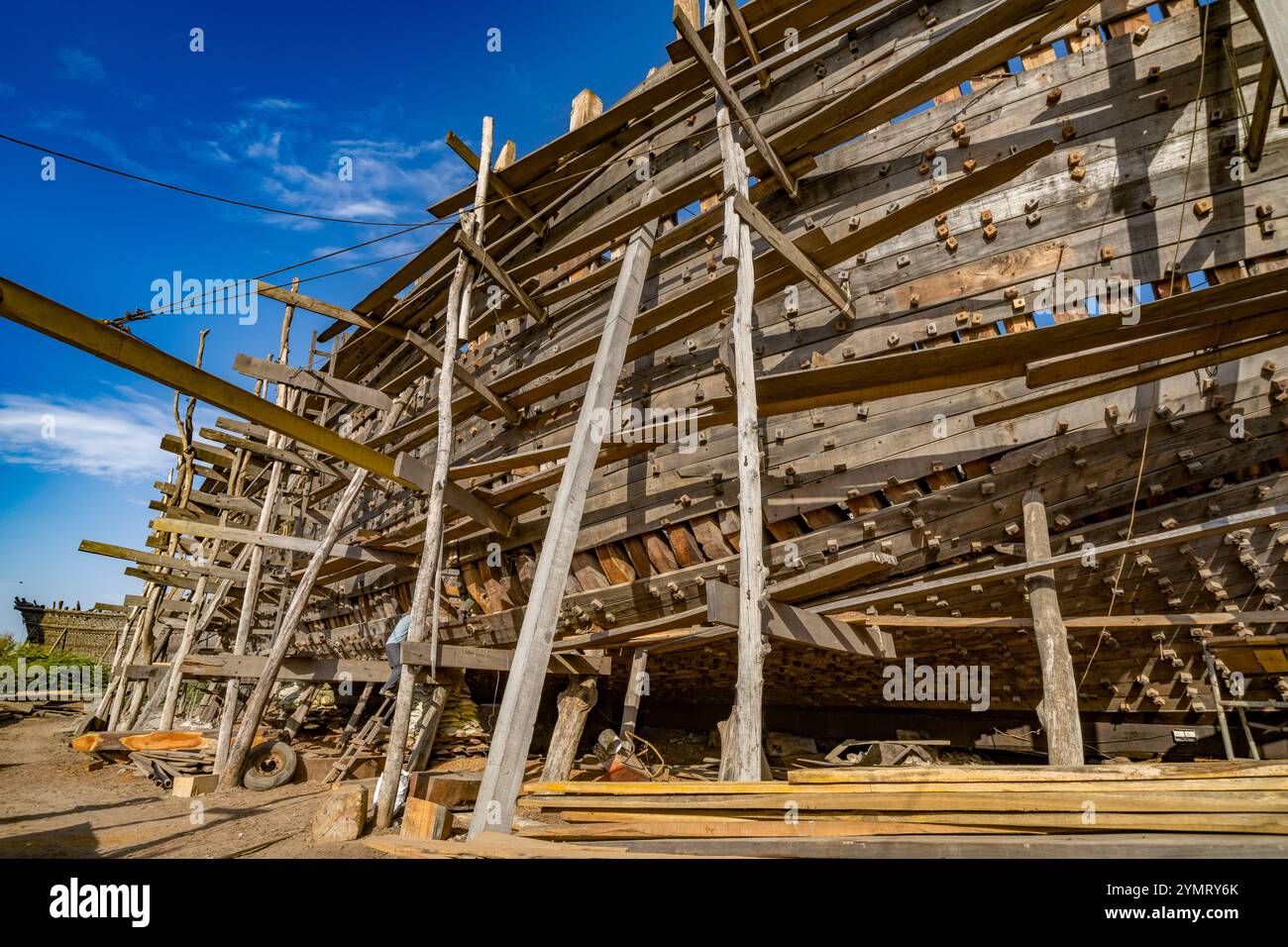 Wooden planks and support beams forming the hull of a ship during ...