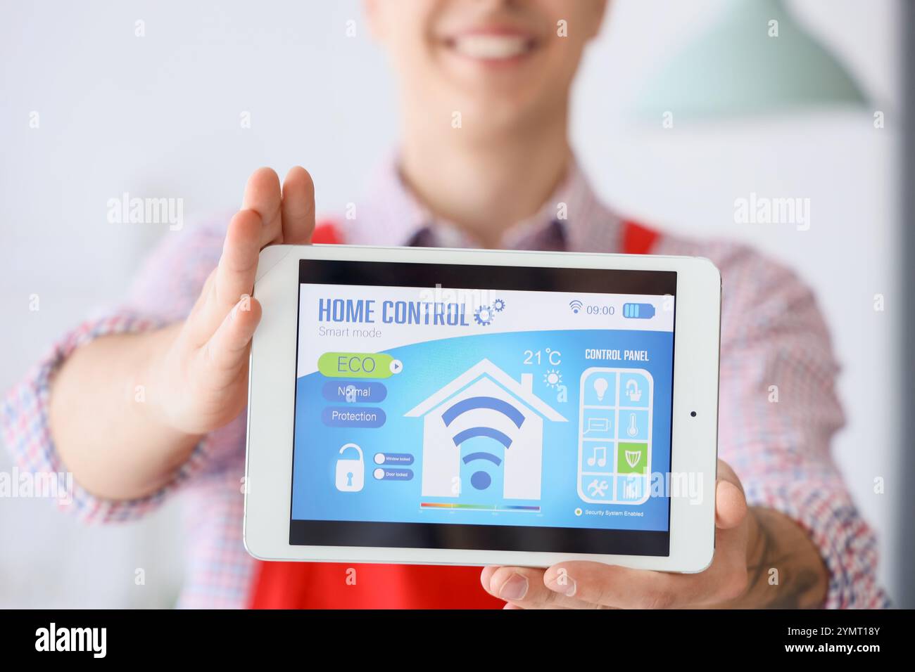 Male worker showing tablet with installed alarm security system in ...