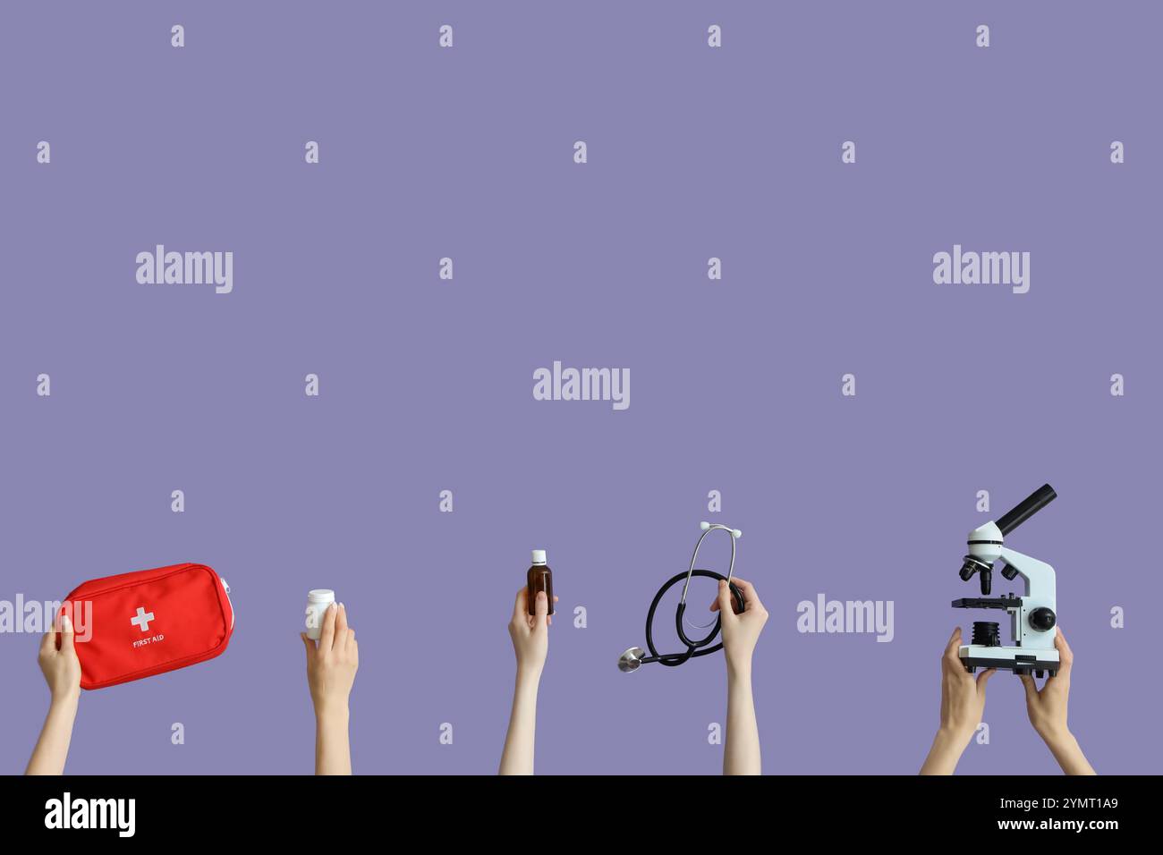 Hands with first aid kit, stethoscope, microscope and pills on lilac ...
