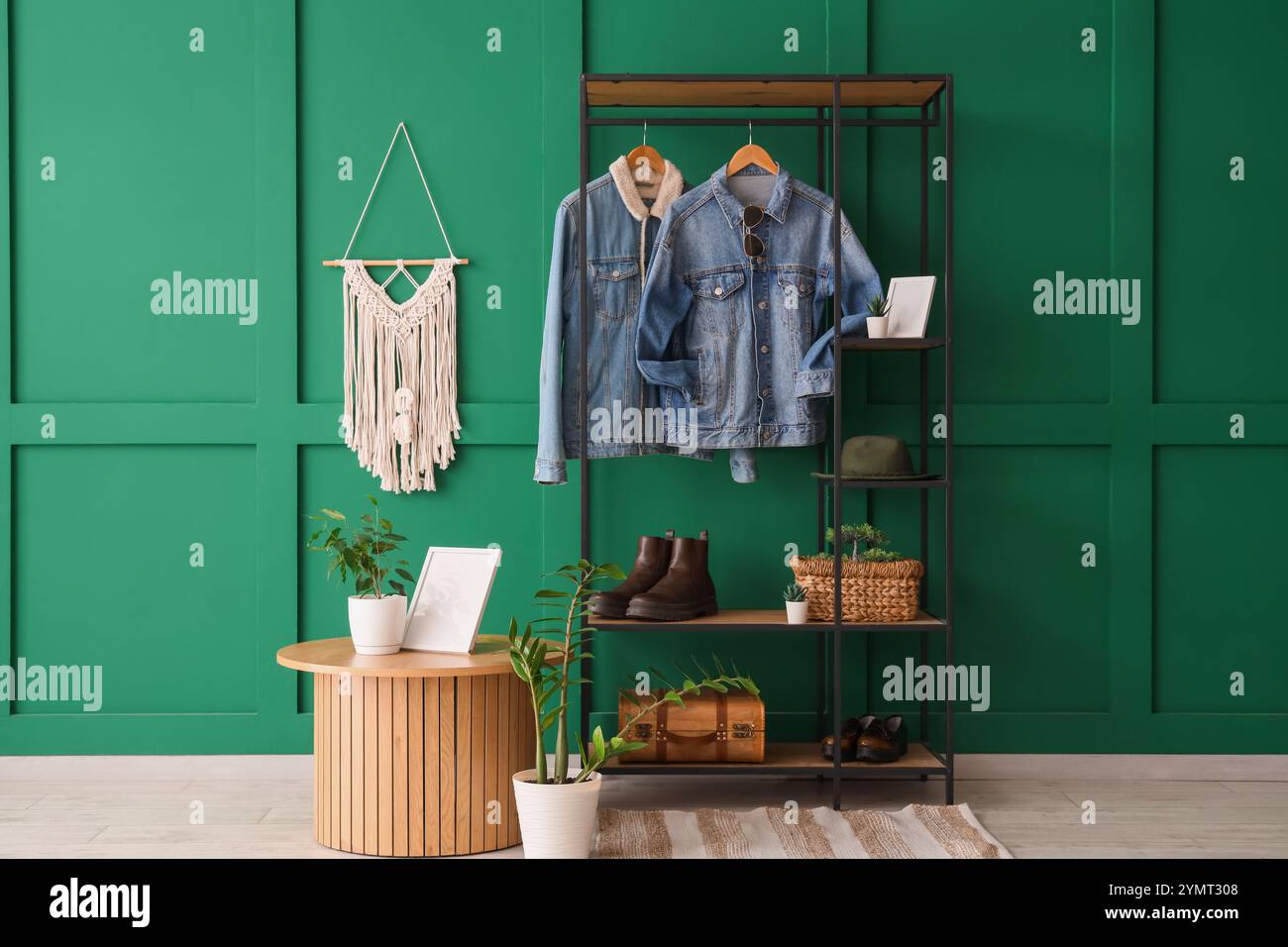 Interior of room with rack, denim jackets and table Stock Photo - Alamy