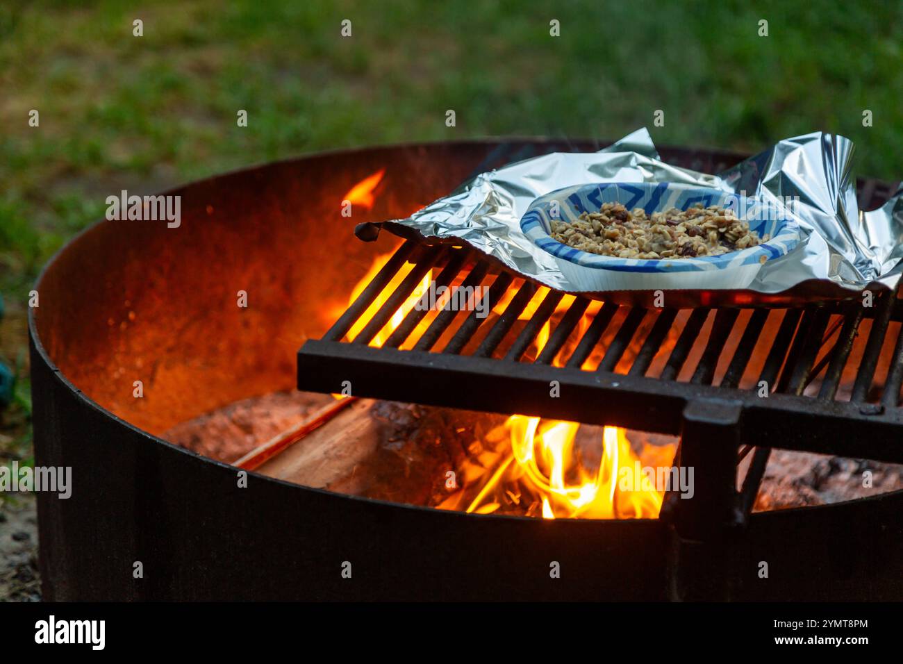 Oatmeal cooking over a fire in a burn barrel Stock Photo - Alamy