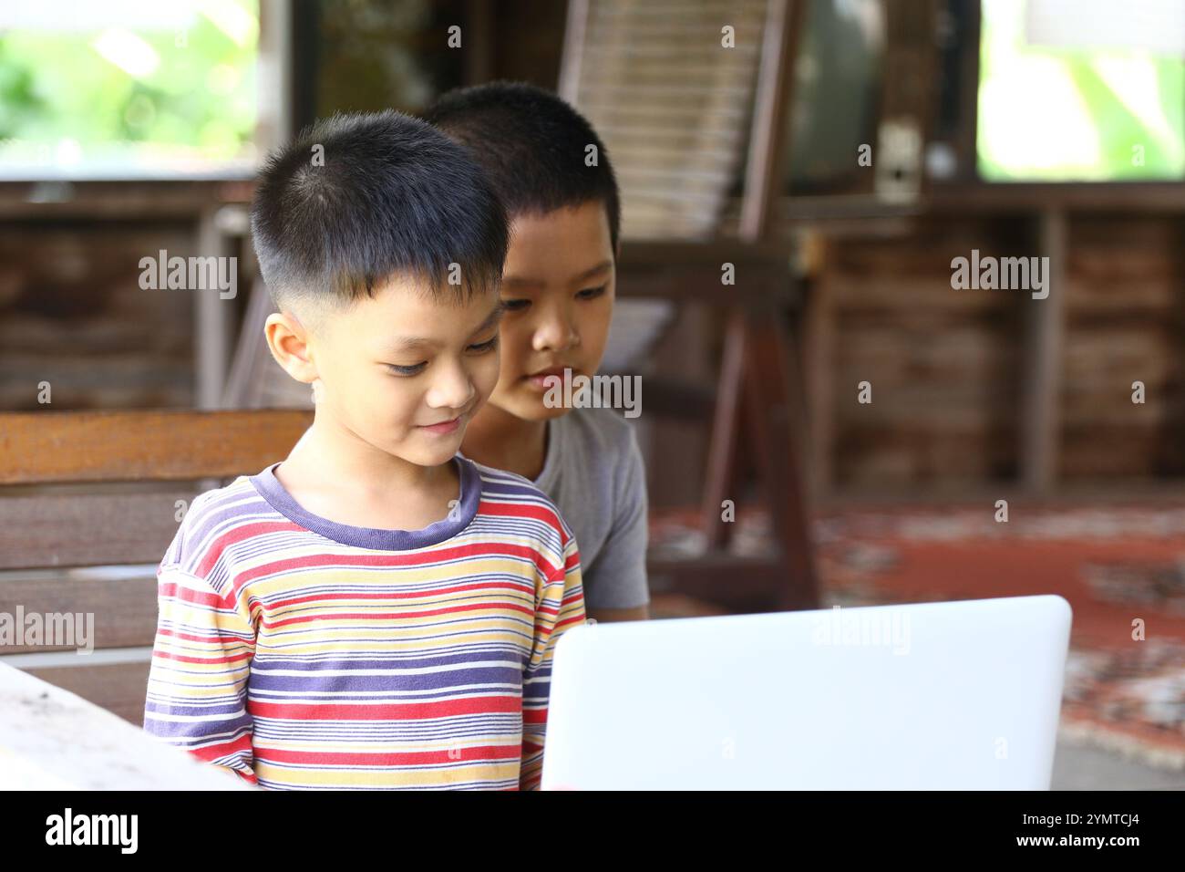 Two children gather around hi-res stock photography and images - Alamy