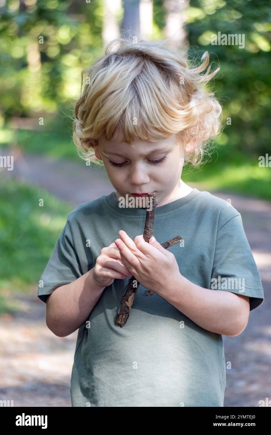 A little boy explores nature on a forest path Stock Photo - Alamy
