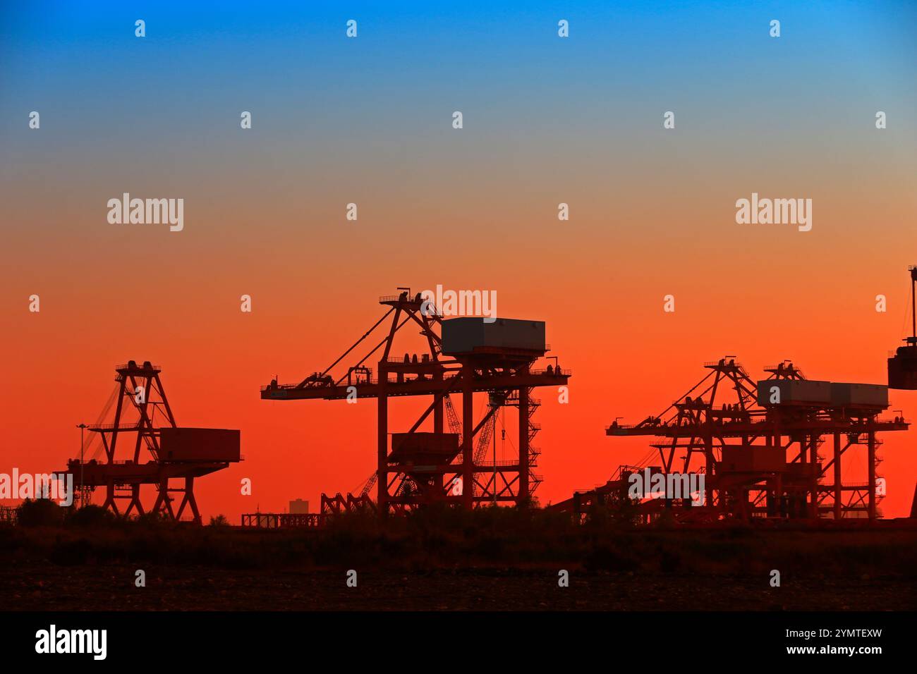Port crane unloading container ships Stock Photo - Alamy