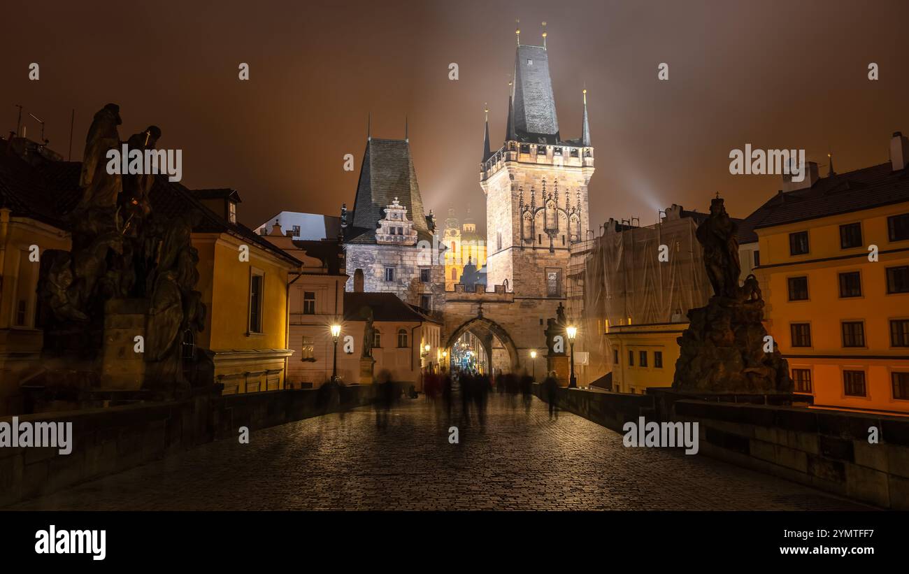 Ancient medieval tower at the entrance to Charles Bridge at night and ...