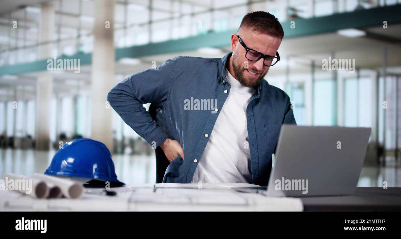 Back Pain Bad Posture Man Sitting In Office Stock Photo - Alamy