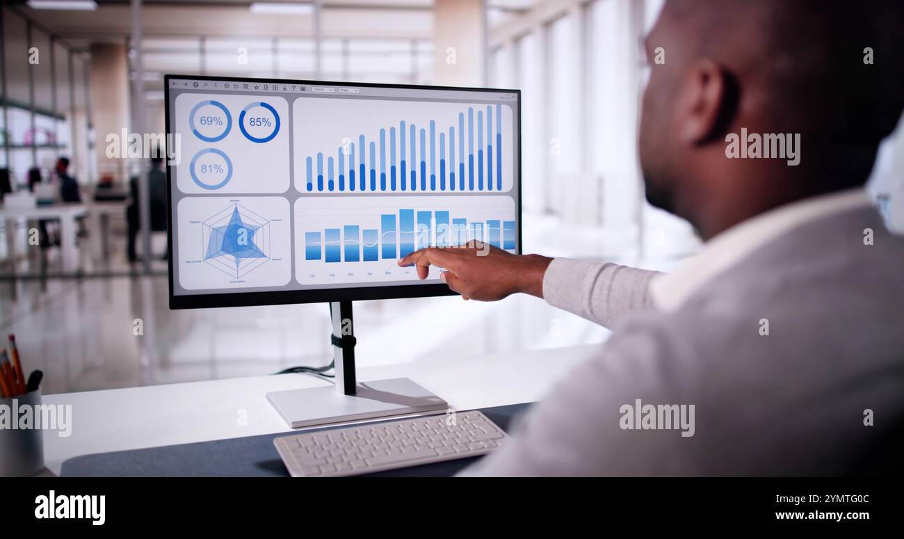 African American Man Analyzing Financial Data On Laptop Computer In ... African American Man Analyzing Financial Data On Laptop Computer In ...