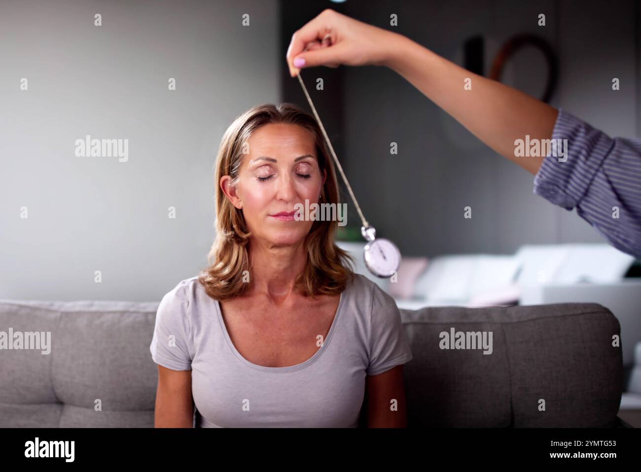 Woman Hypnotized By Watch. Hypnotherapy And Mind Control Stock Photo ...