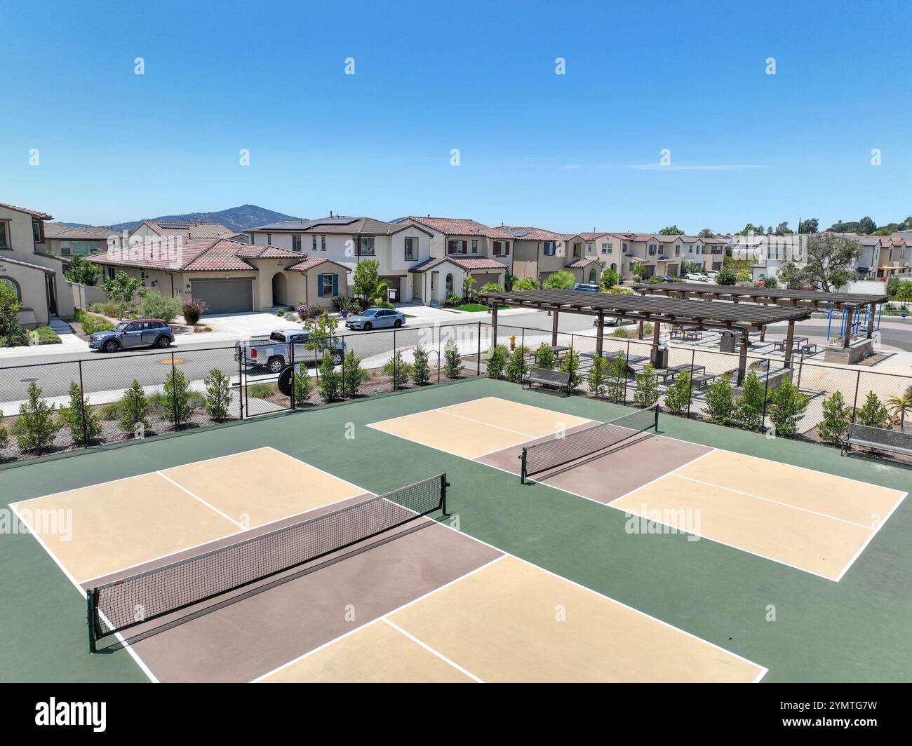 Aerial view of a pickle ball complex with courts beside a playground in ...