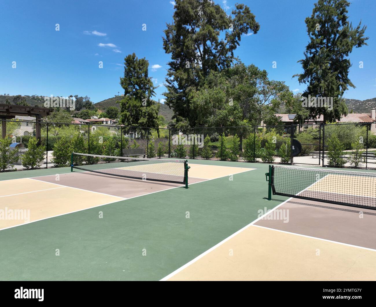 Aerial view of a pickle ball complex with courts beside a playground in ...