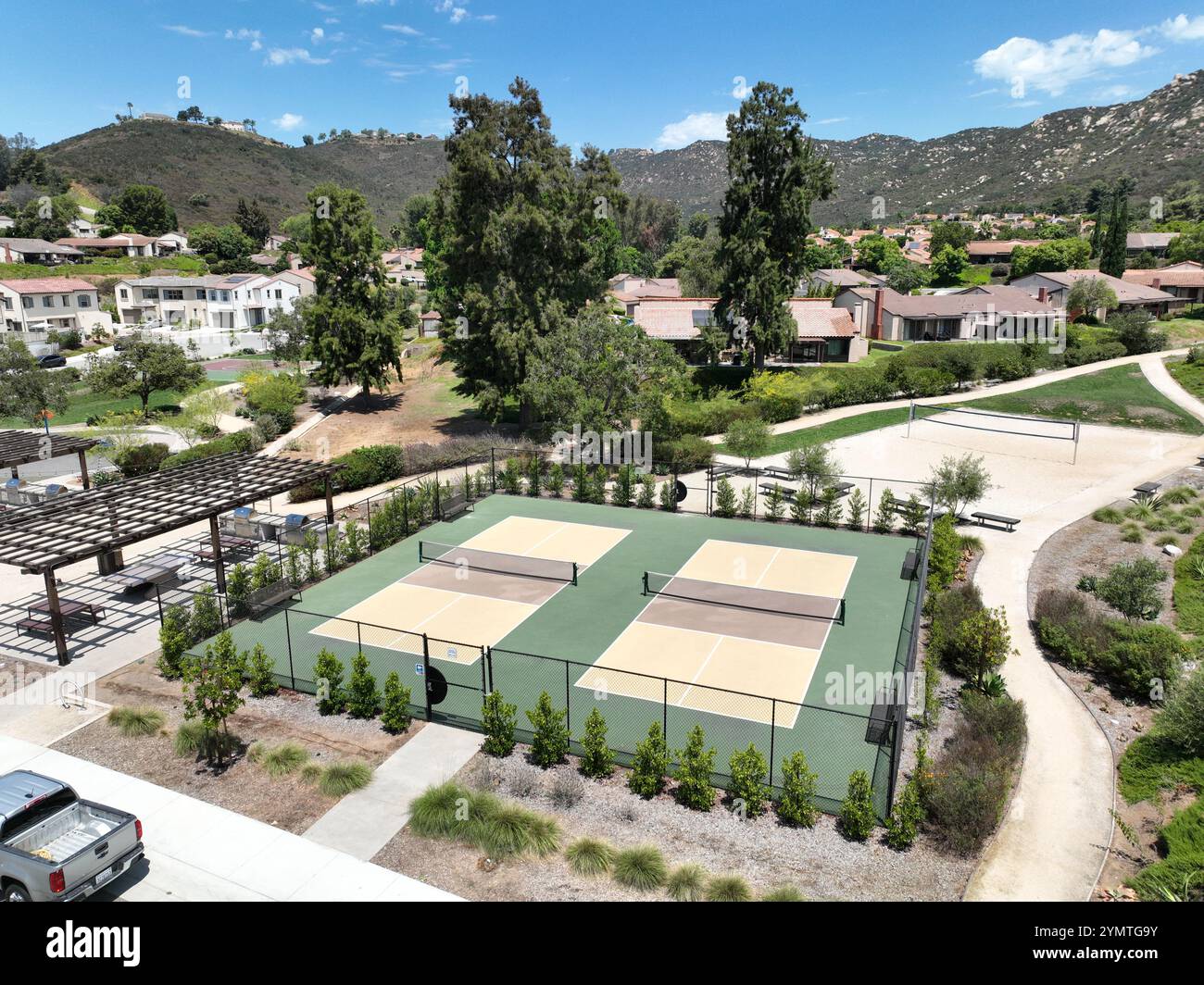 Aerial view of a pickle ball complex with courts beside a playground in ...