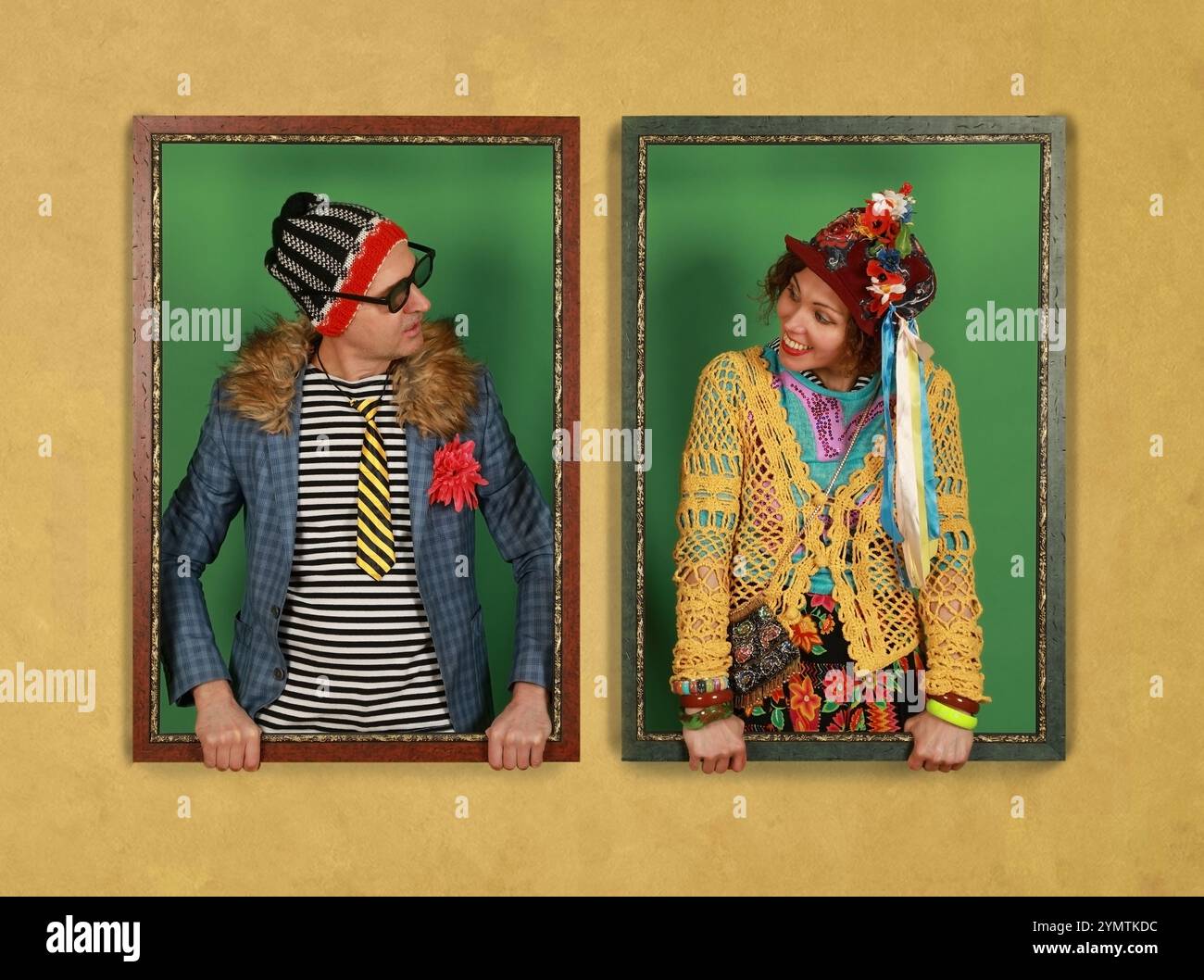 A couple of freaks hold picture frames and look at each other on a ...