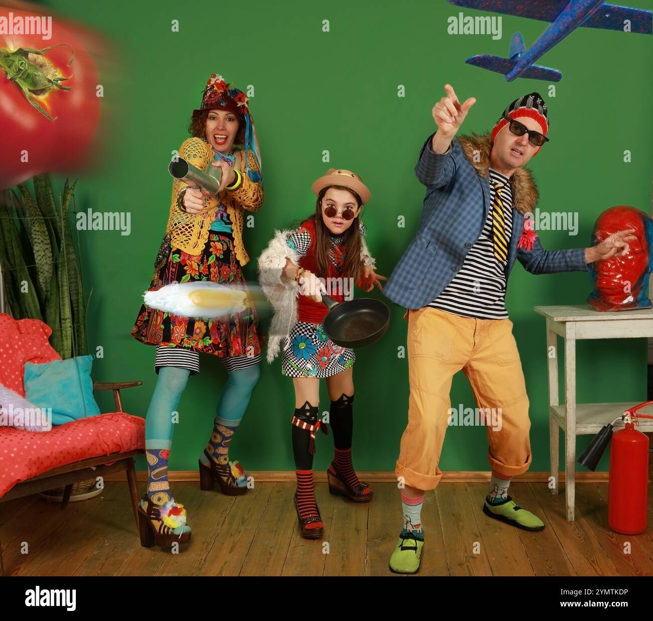 Family of freaks poses and throws a tomato, scrambled eggs and a toy ...