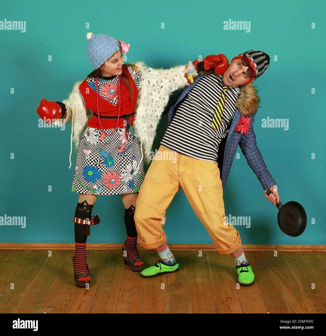 Freaks dad and daughter fool around in the studio on a blue background ...