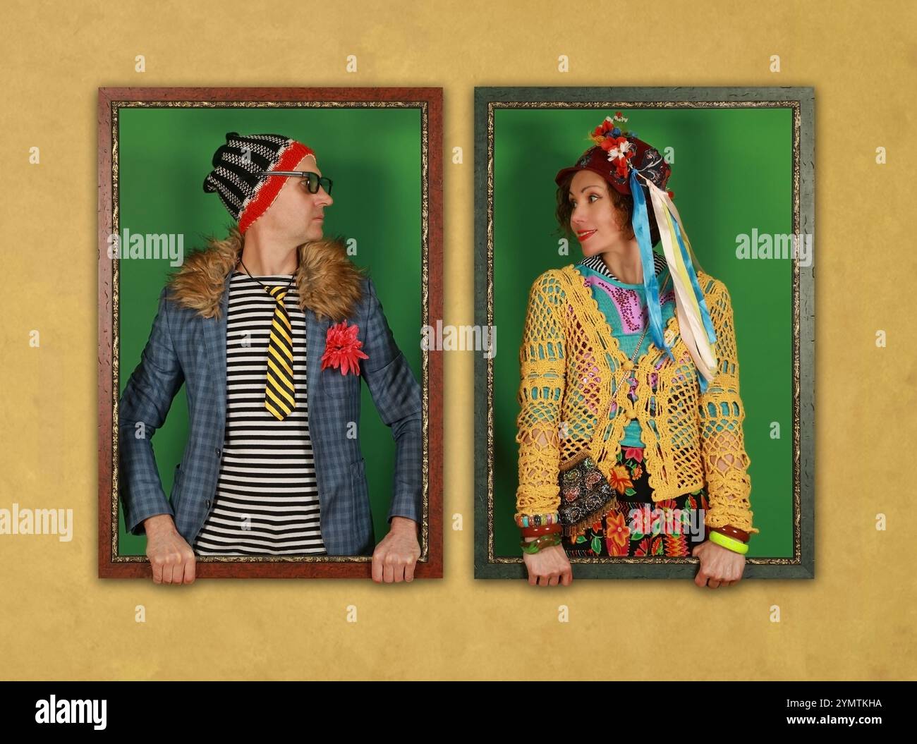 Funny couple of freaks hold picture frames and look at the camera on a ...