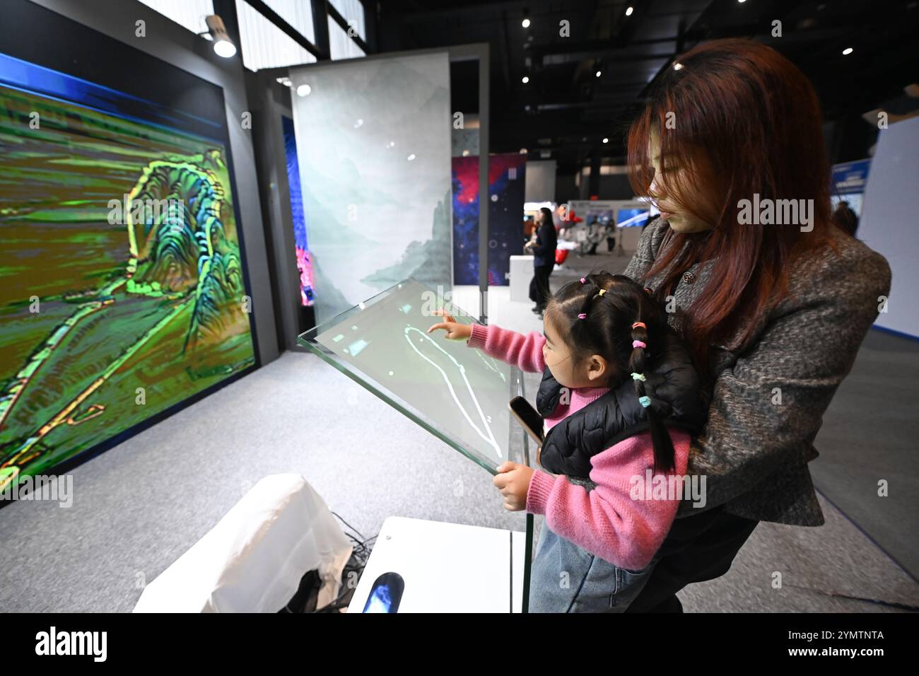 Visitors experience AI painting, Nov.21, 2024. Wuzhen,China.21th ...