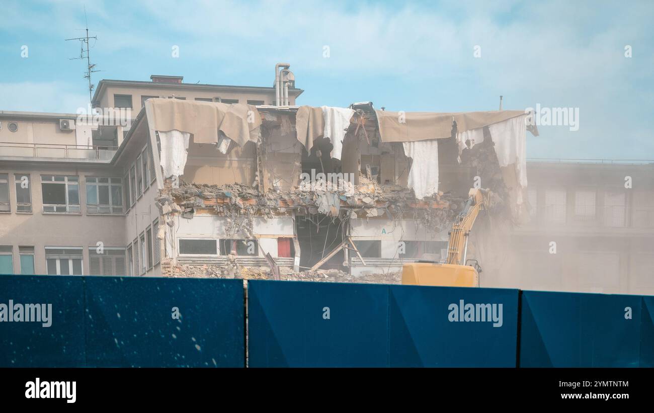 Demolishing an industrial house with a wrecker and excavator, making ...