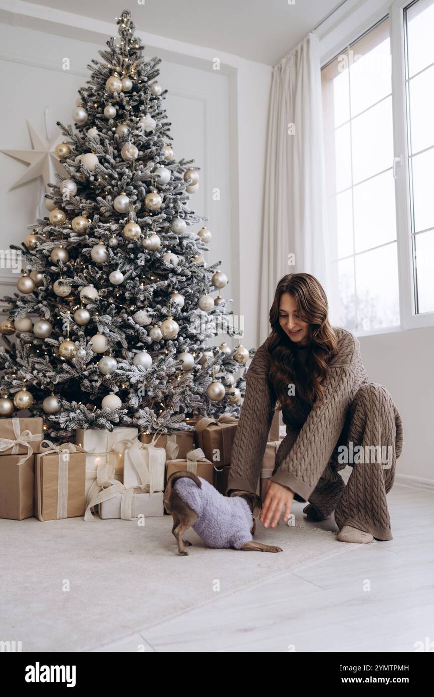 Elegant Christmas Tree and Woman Stock Photo - Alamy