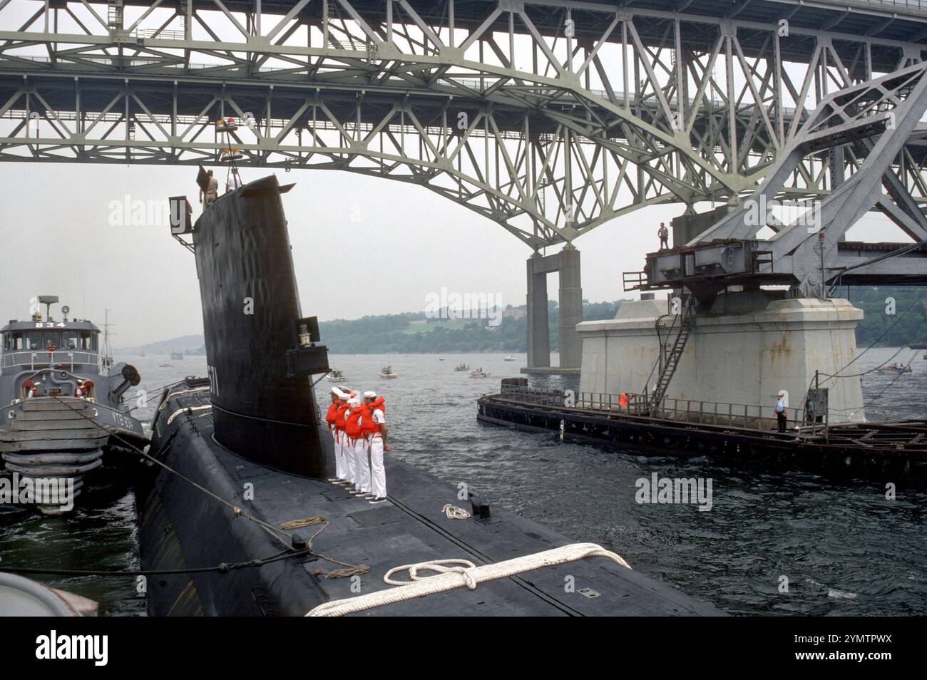 Crewmen stand in formation aboard the nuclear-powered attack submarine ...
