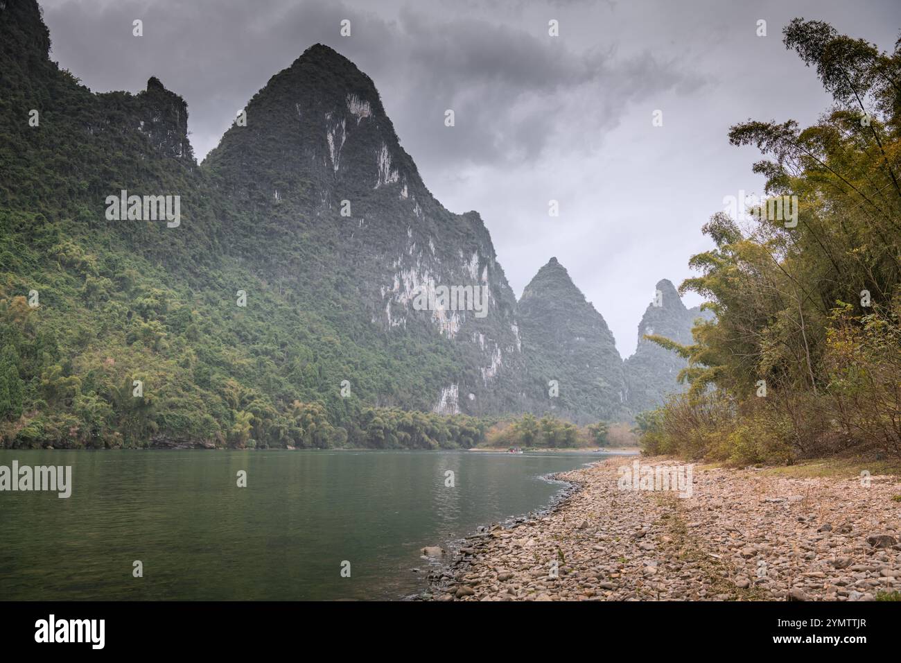 The shores of the Li river in Xing Ping, Guilin, China. Cloudy sky with ...
