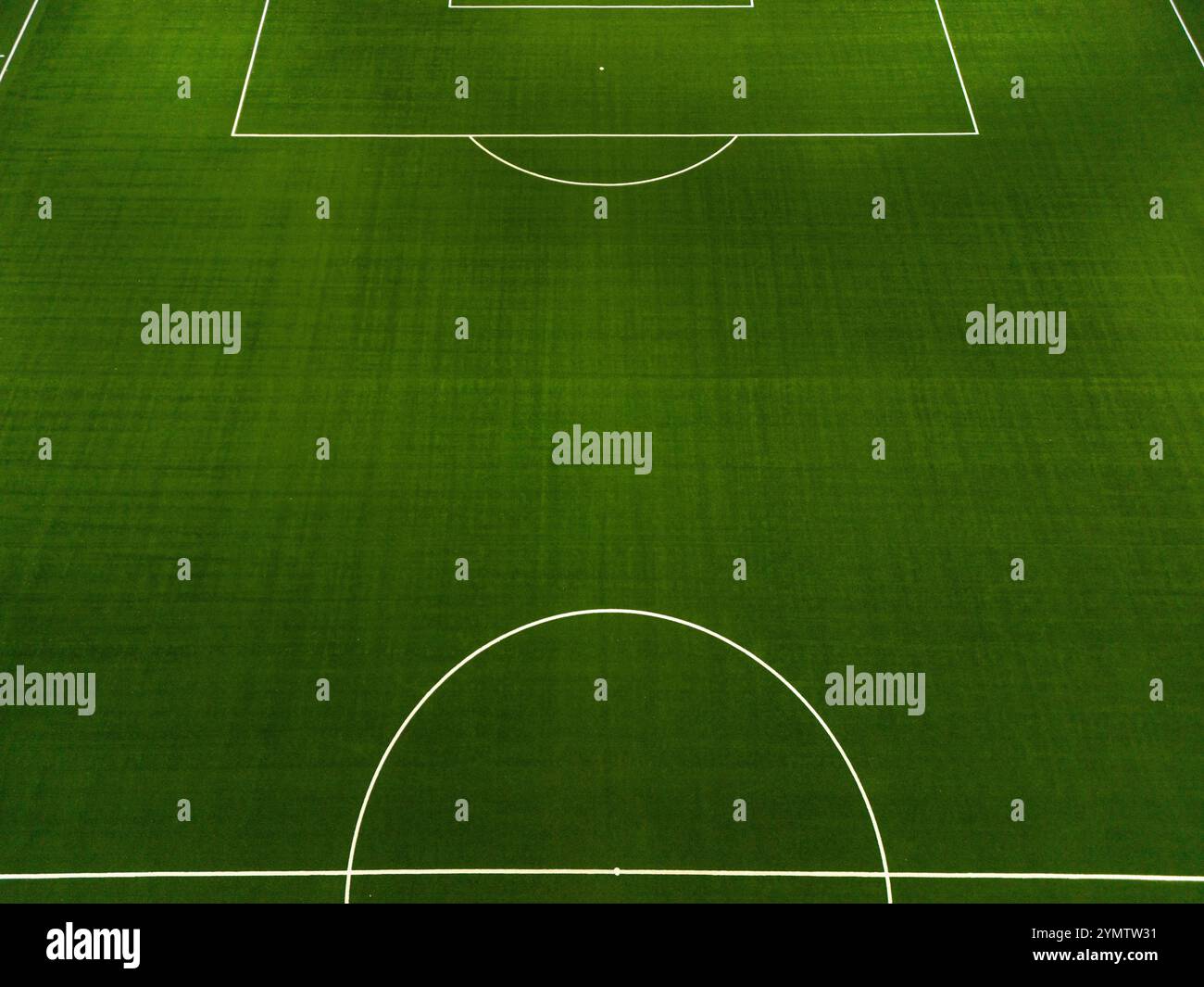 Green grass and white lines. Aerial closeup of the midfield circle and ...