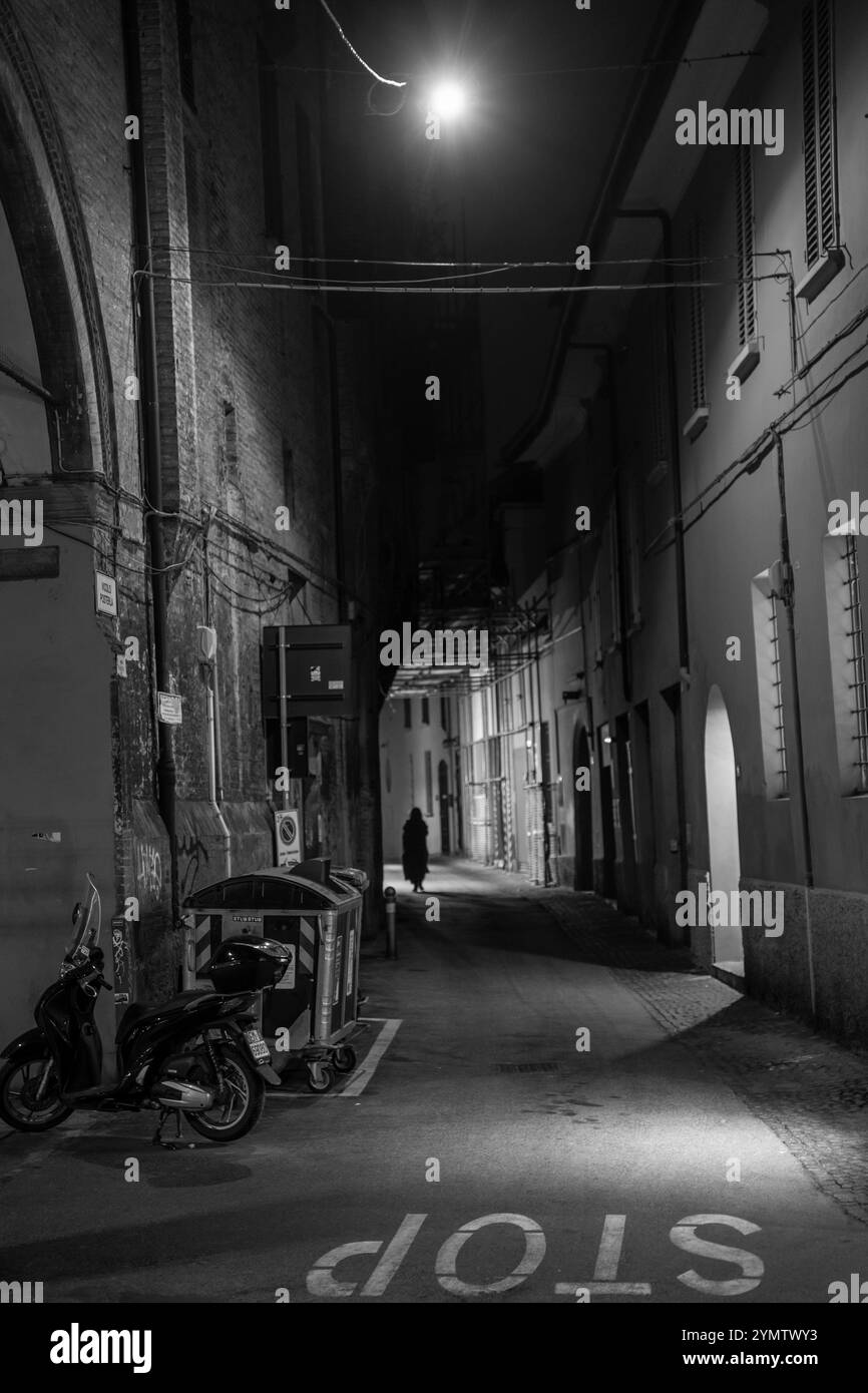 Old houses on a narrow street at night, with stop sign on floor in ...