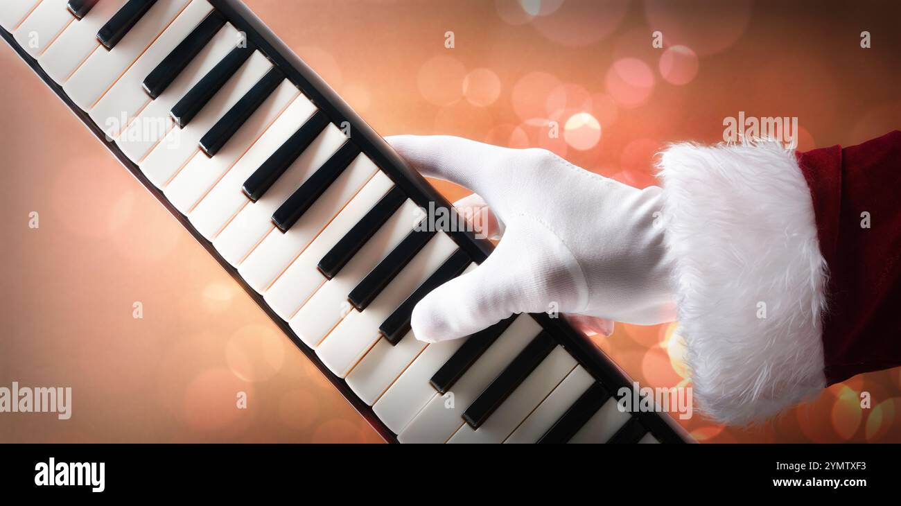 Santa's hand holding a piano with isolated reddish brown background ...