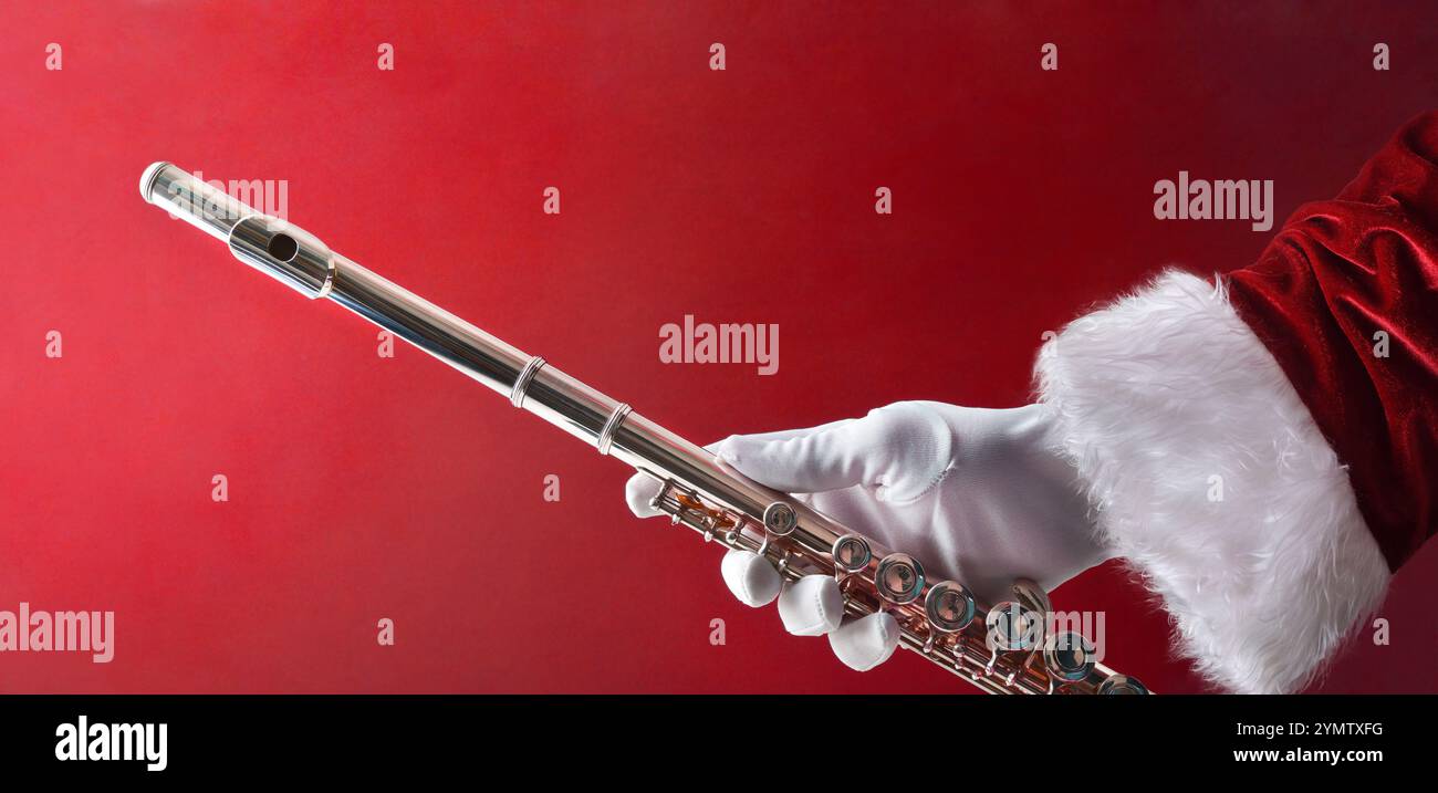Santa's hand showing a metal transverse flute on a red gradient ...