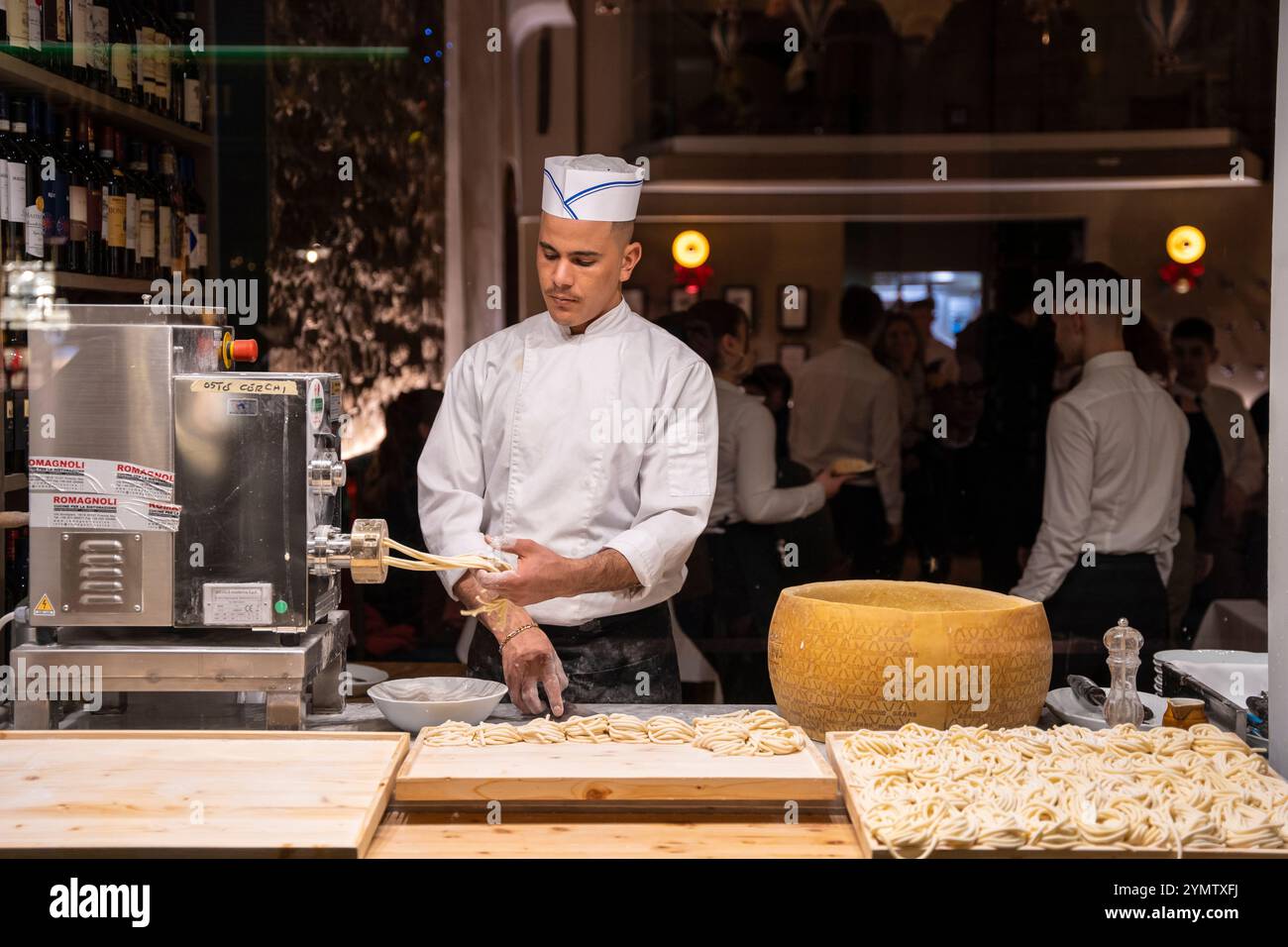 Photo of chef preparing pasta in a restaurant window with clean kitchen ...
