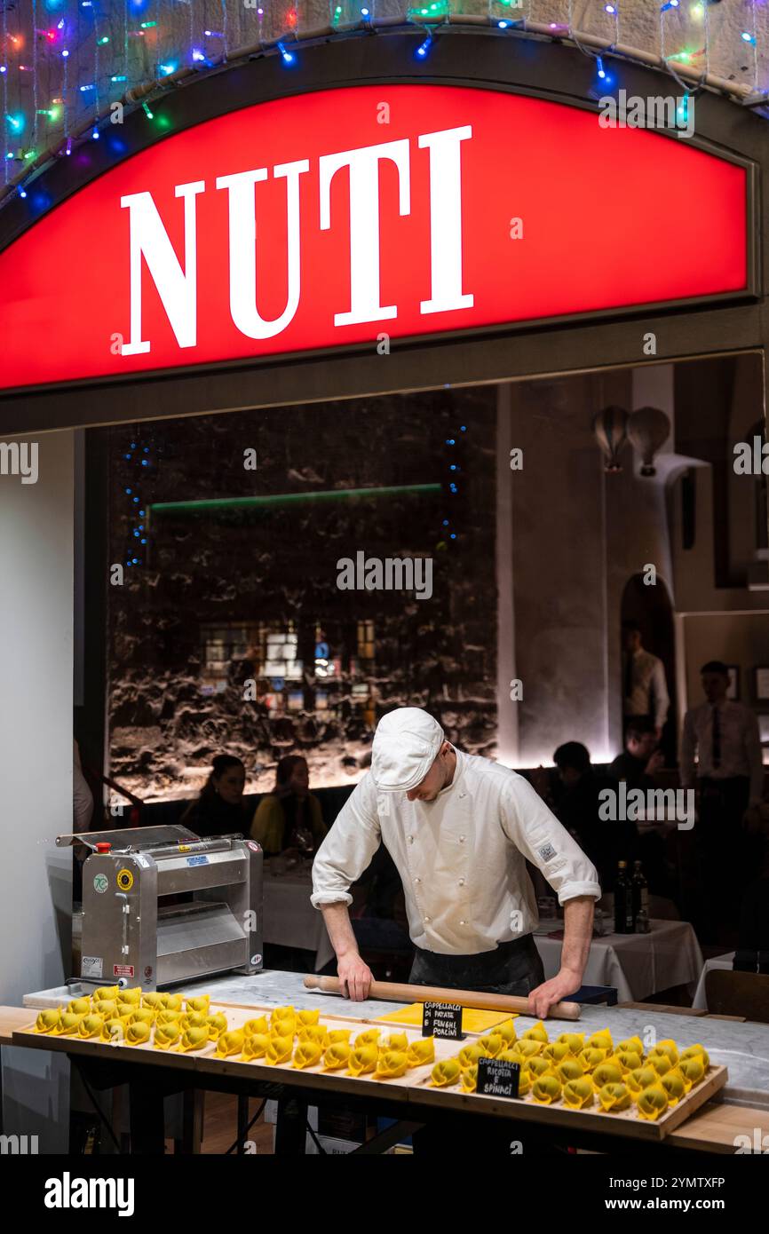 Photo of chef preparing pasta in a restaurant window with clean kitchen ...