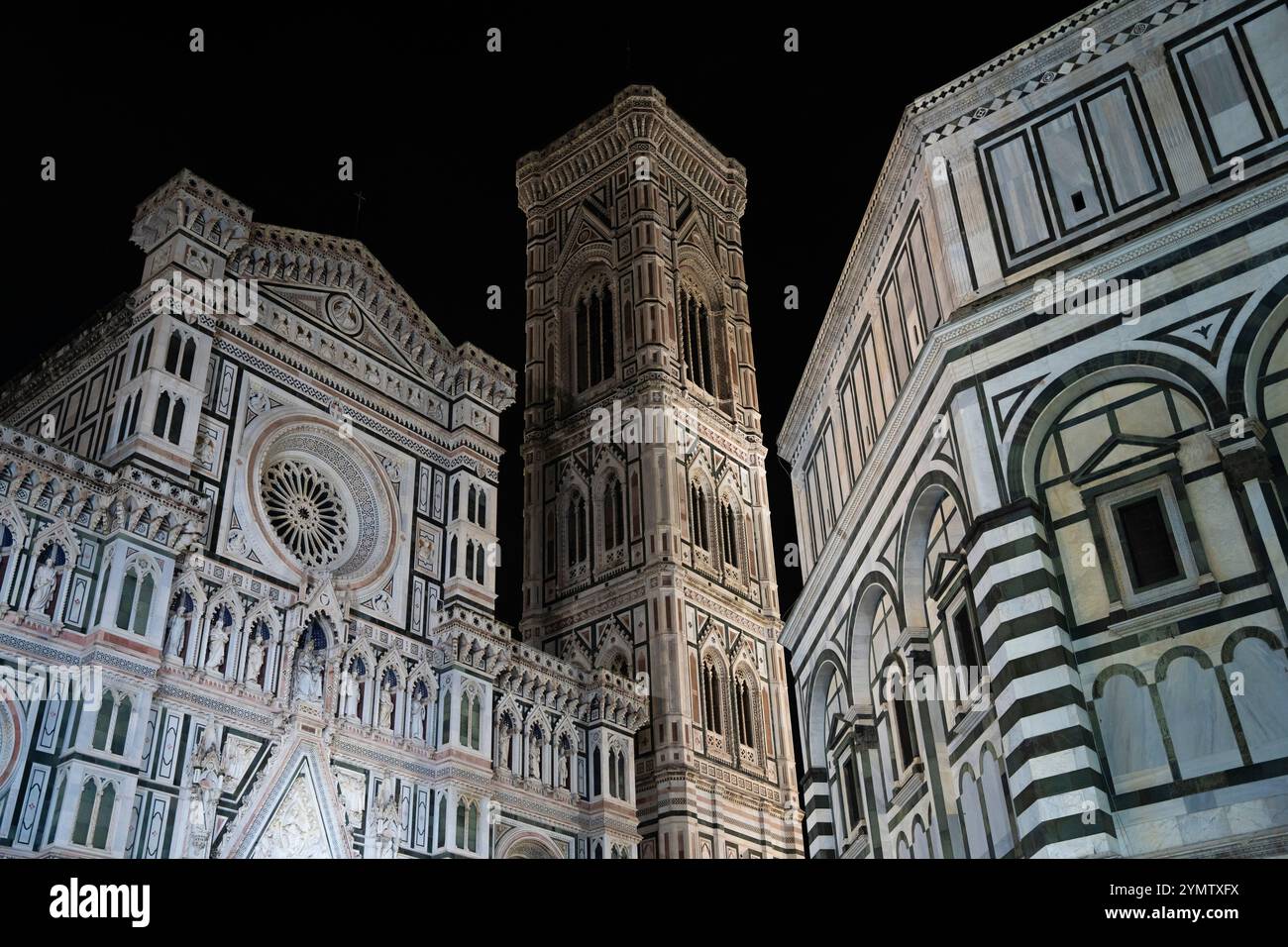 Night view of Ornate colorful marble facade of the Duomo Cathedral or ...
