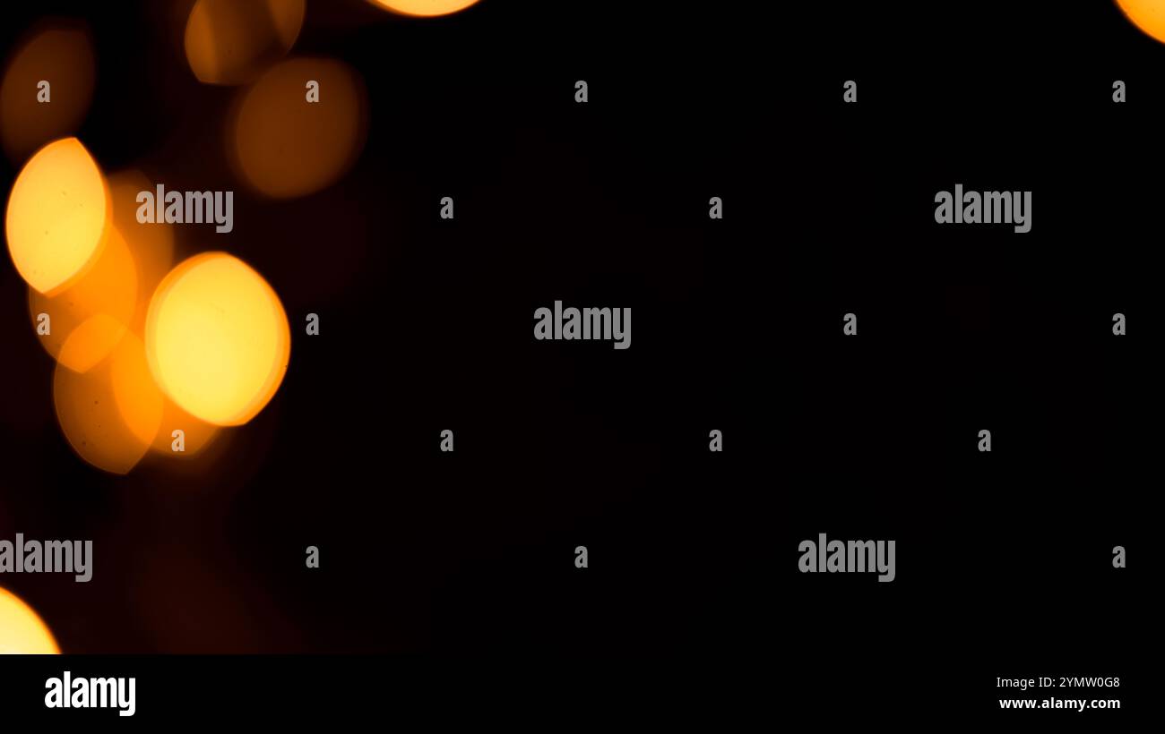 Bright yellow, gold lights, bokeh on black background. festive texture ...
