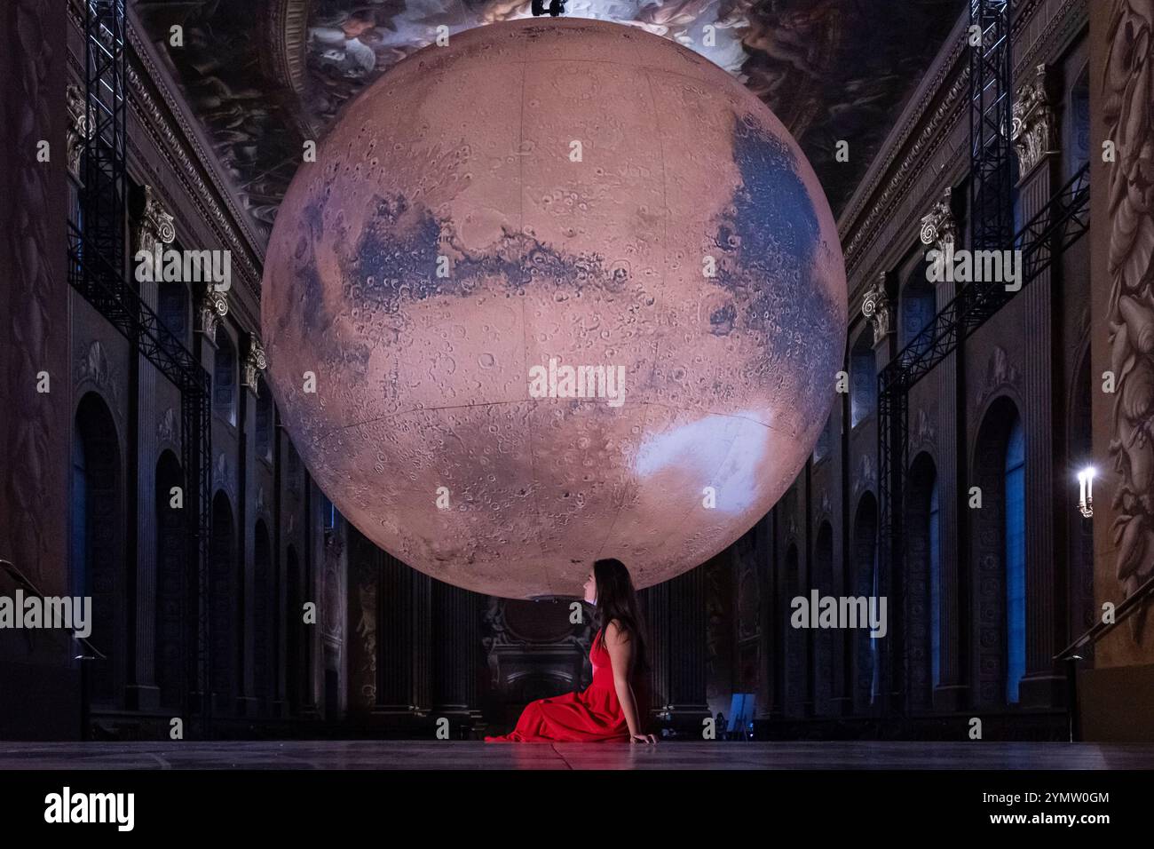 London, UK. 23 November 2024. A staff member with ‘Mars’ by artist Luke ...