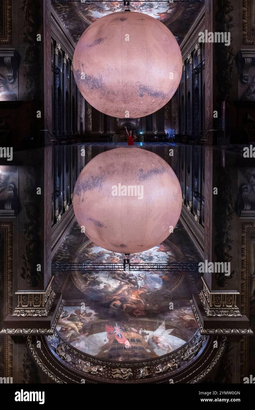 London, UK. 23 November 2024. A staff member with ‘Mars’ by artist Luke ...