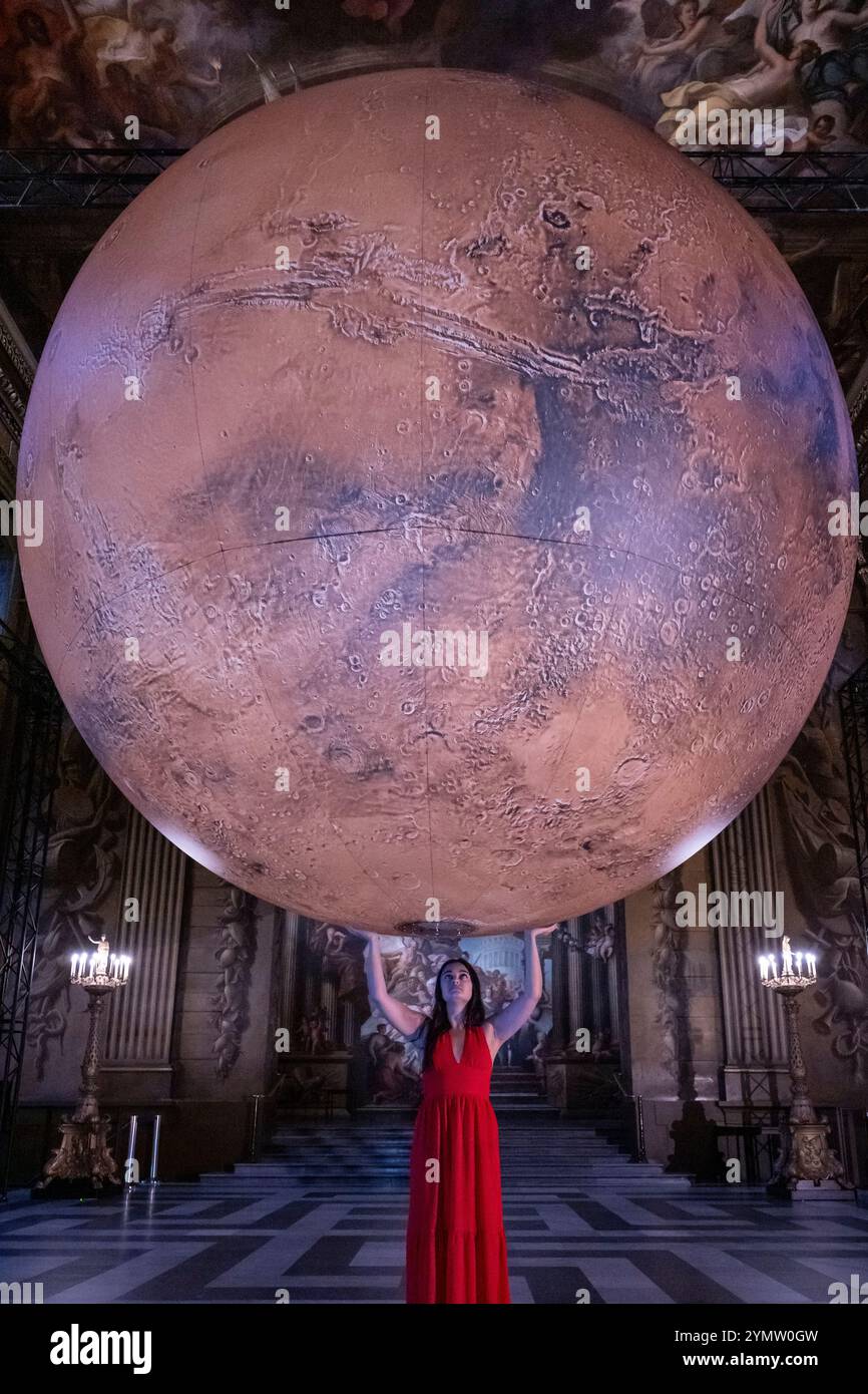 London, UK. 23 November 2024. A staff member with ‘Mars’ by artist Luke ...