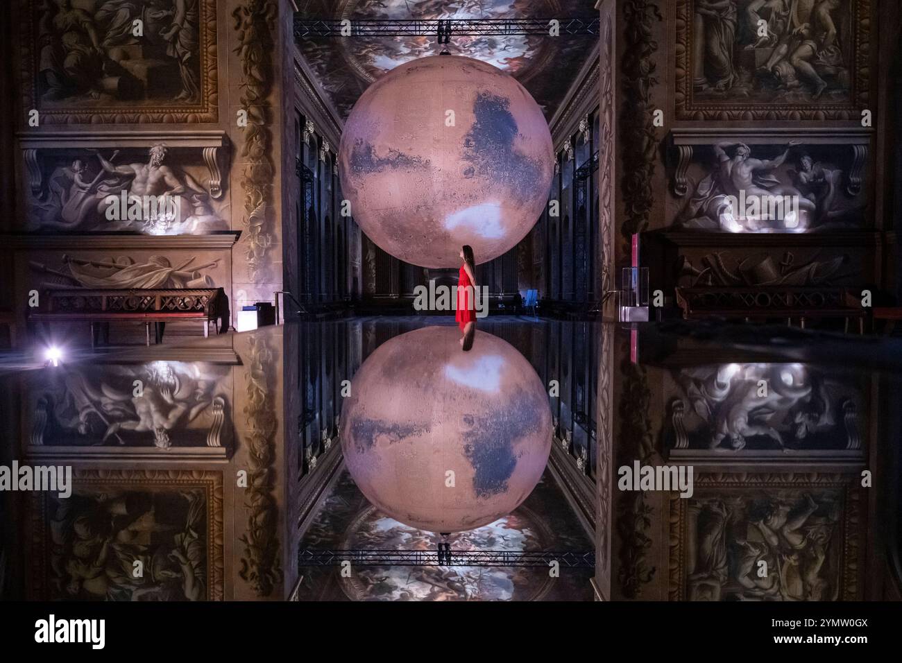 London, UK. 23 November 2024. A staff member with ‘Mars’ by artist Luke ...