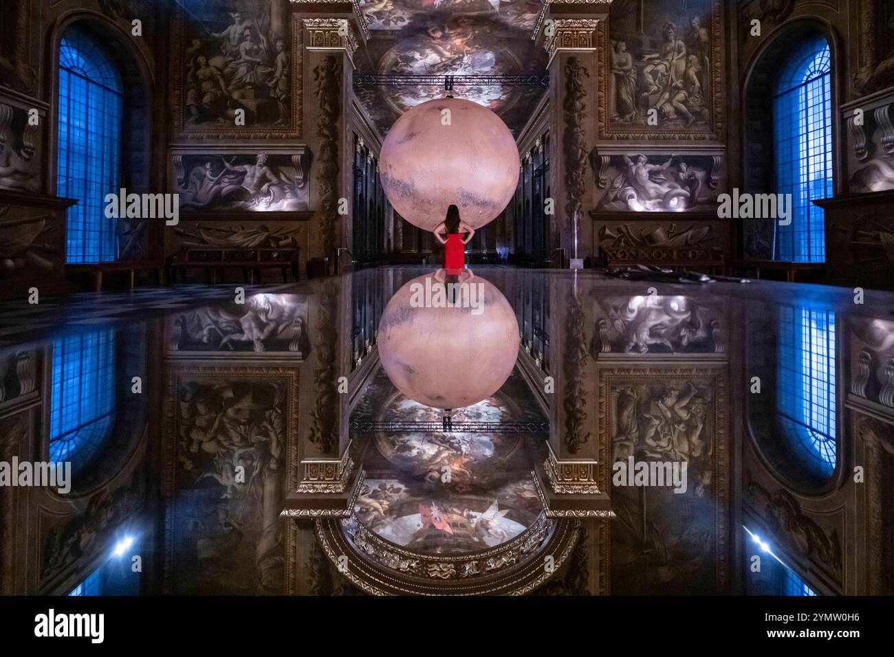 London, UK. 23 November 2024. A staff member with ‘Mars’ by artist Luke ...