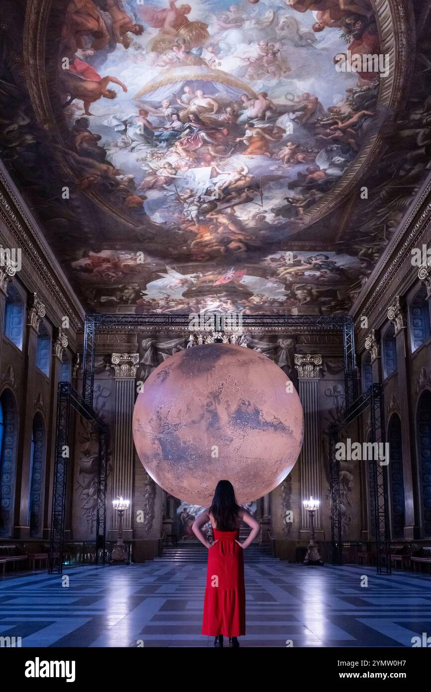 London, UK. 23 November 2024. A staff member with ‘Mars’ by artist Luke ...