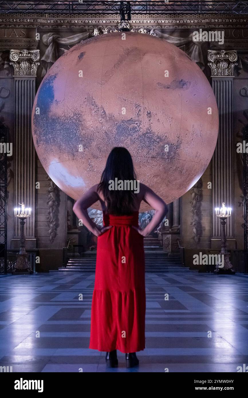 London, UK. 23 November 2024. A staff member with ‘Mars’ by artist Luke ...