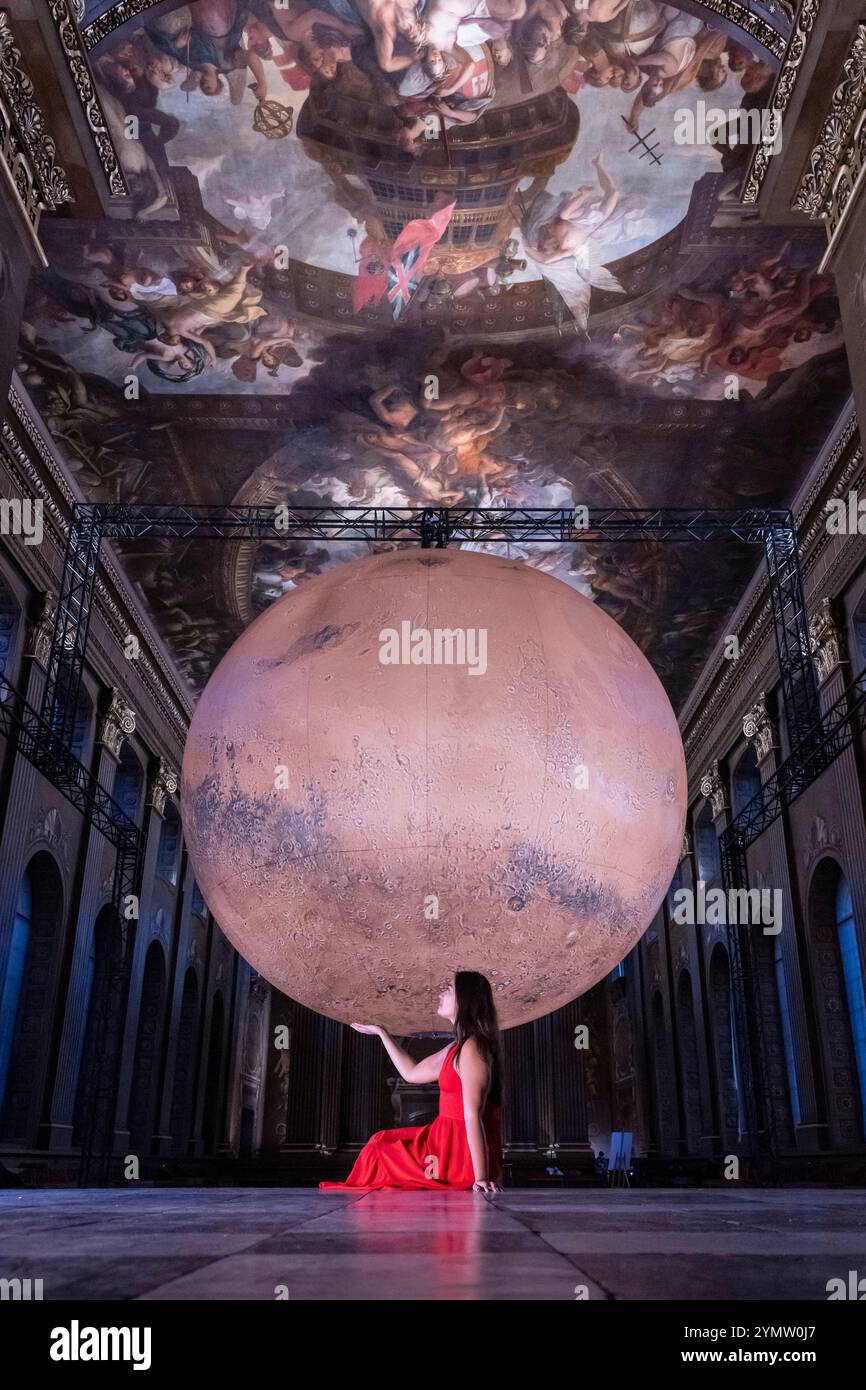 London, UK. 23 November 2024. A staff member with ‘Mars’ by artist Luke ...