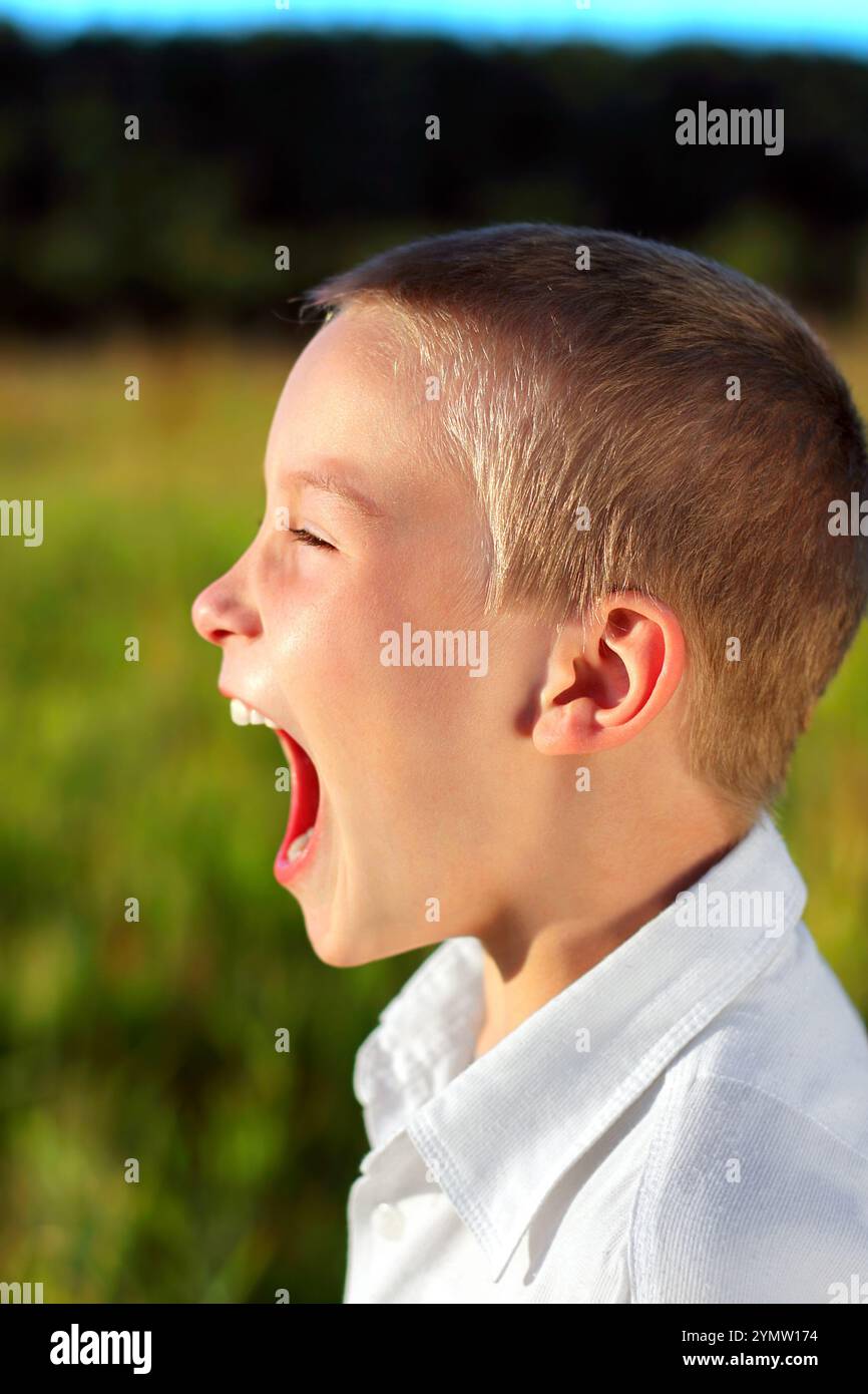 portrait of screaming boy in profile Stock Photo - Alamy