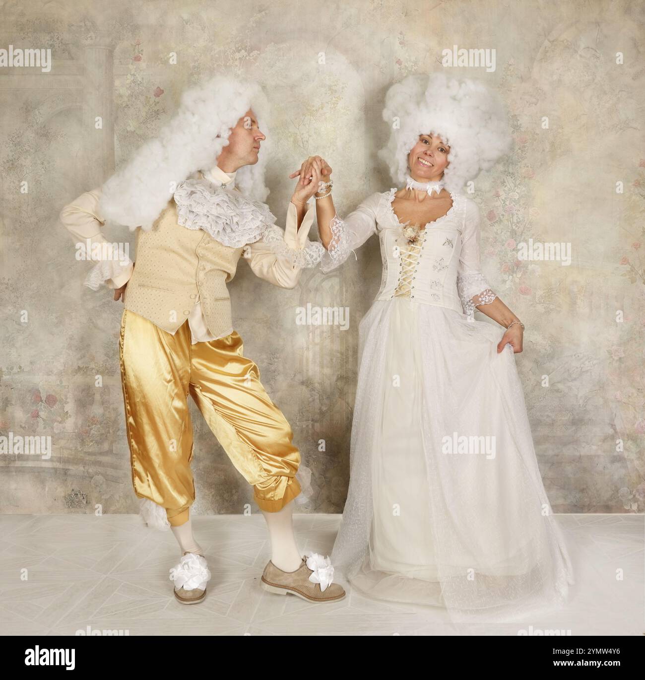 Funny couple in Baroque style clothes dancing in the studio Stock Photo ...