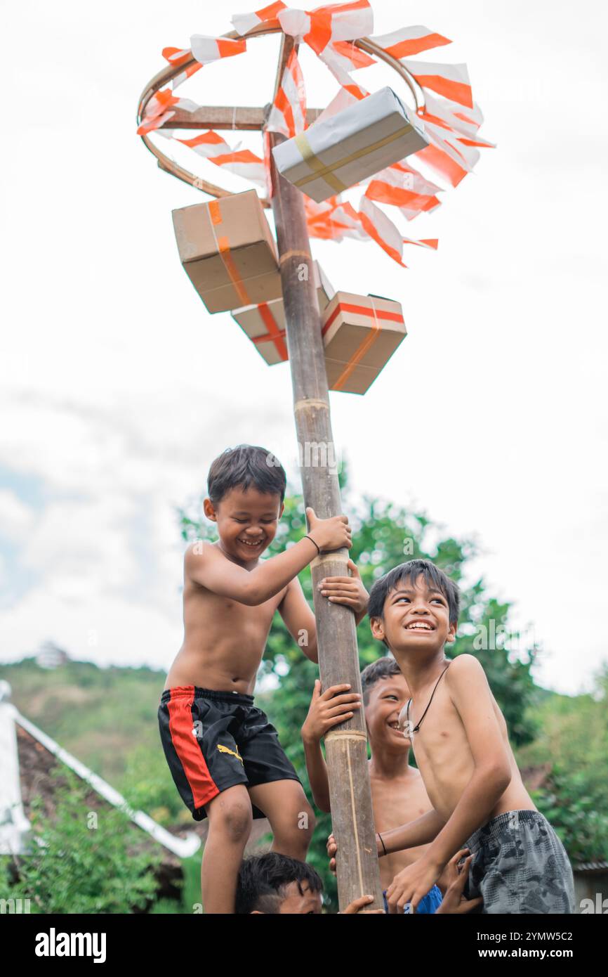laughing children happily climbing during a betel nut climbing ...